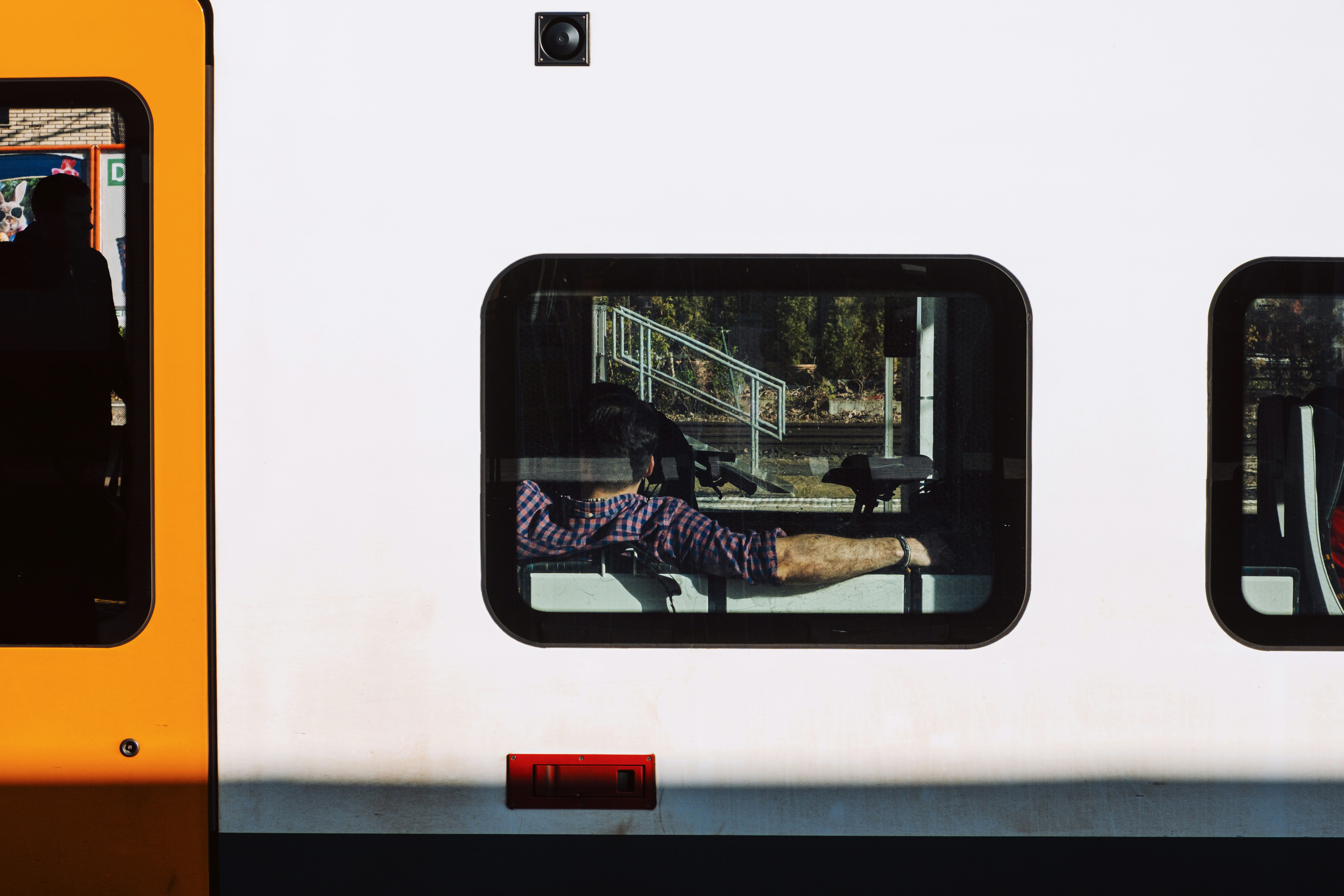 Windowed Lullaby: A Passenger at Rest on a Quiet Train Car