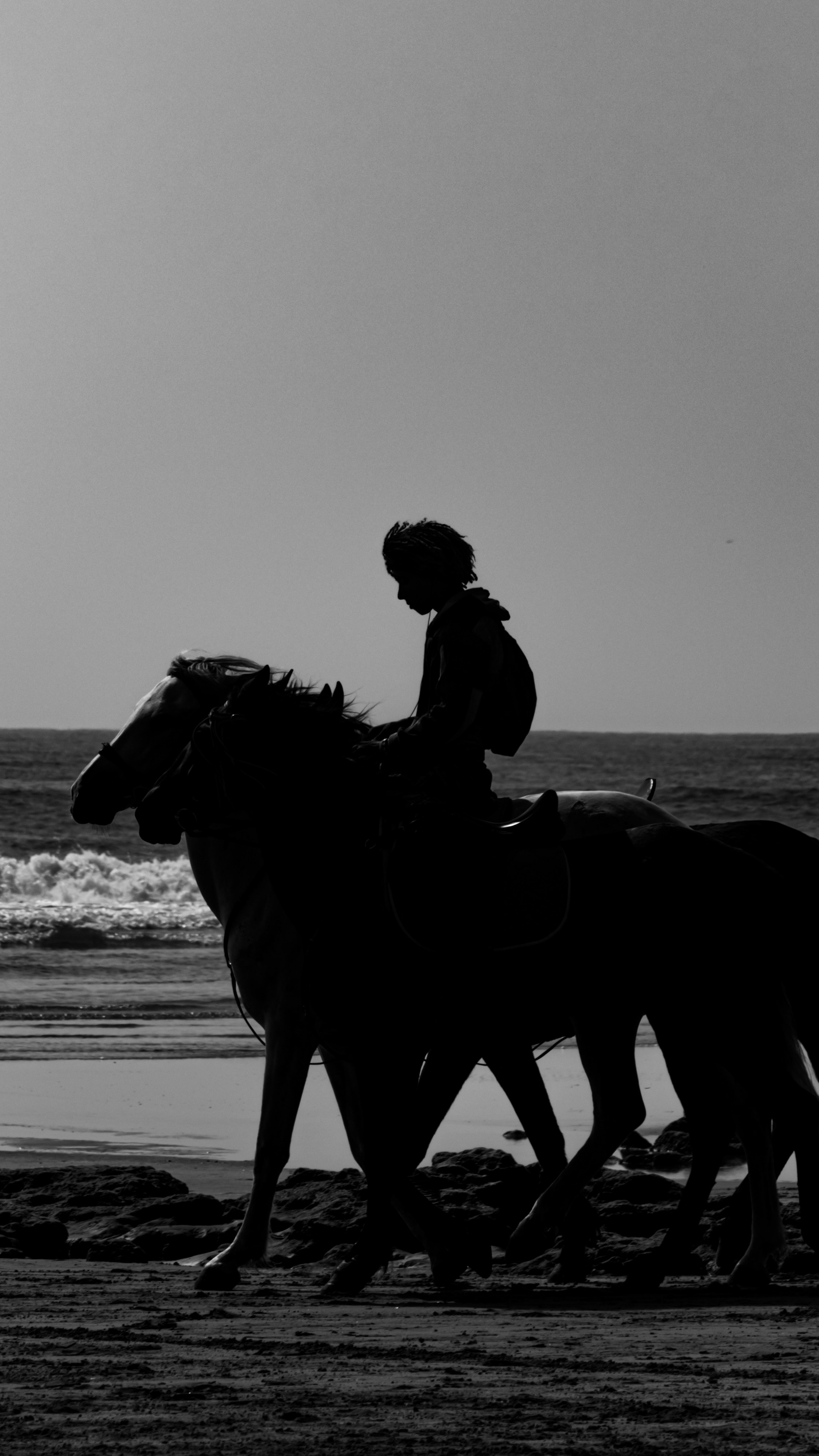 Silhouette Ride: A Lone Rider Traverses the Shoreline