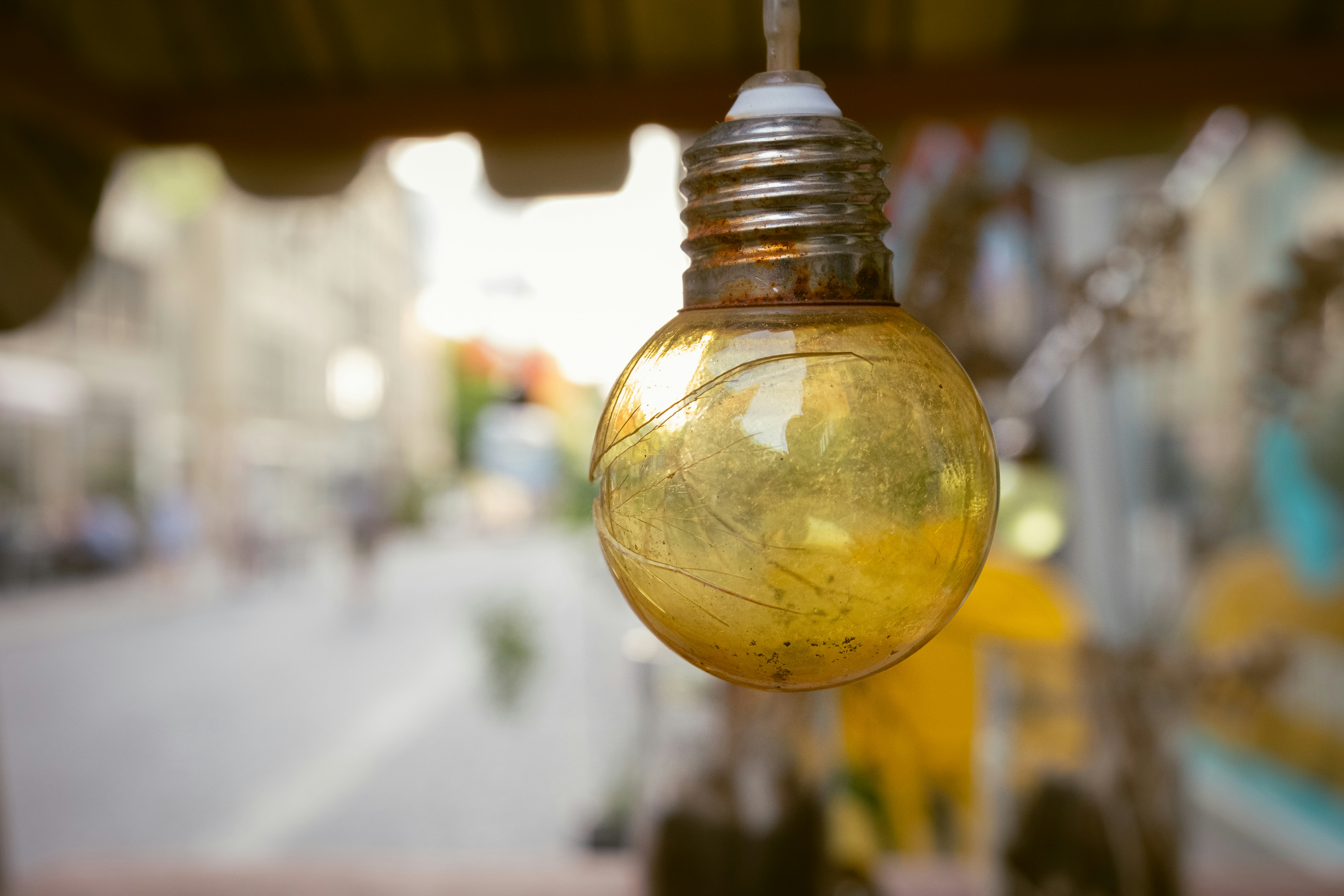 Hanging Bulb in Soft Urban Blur