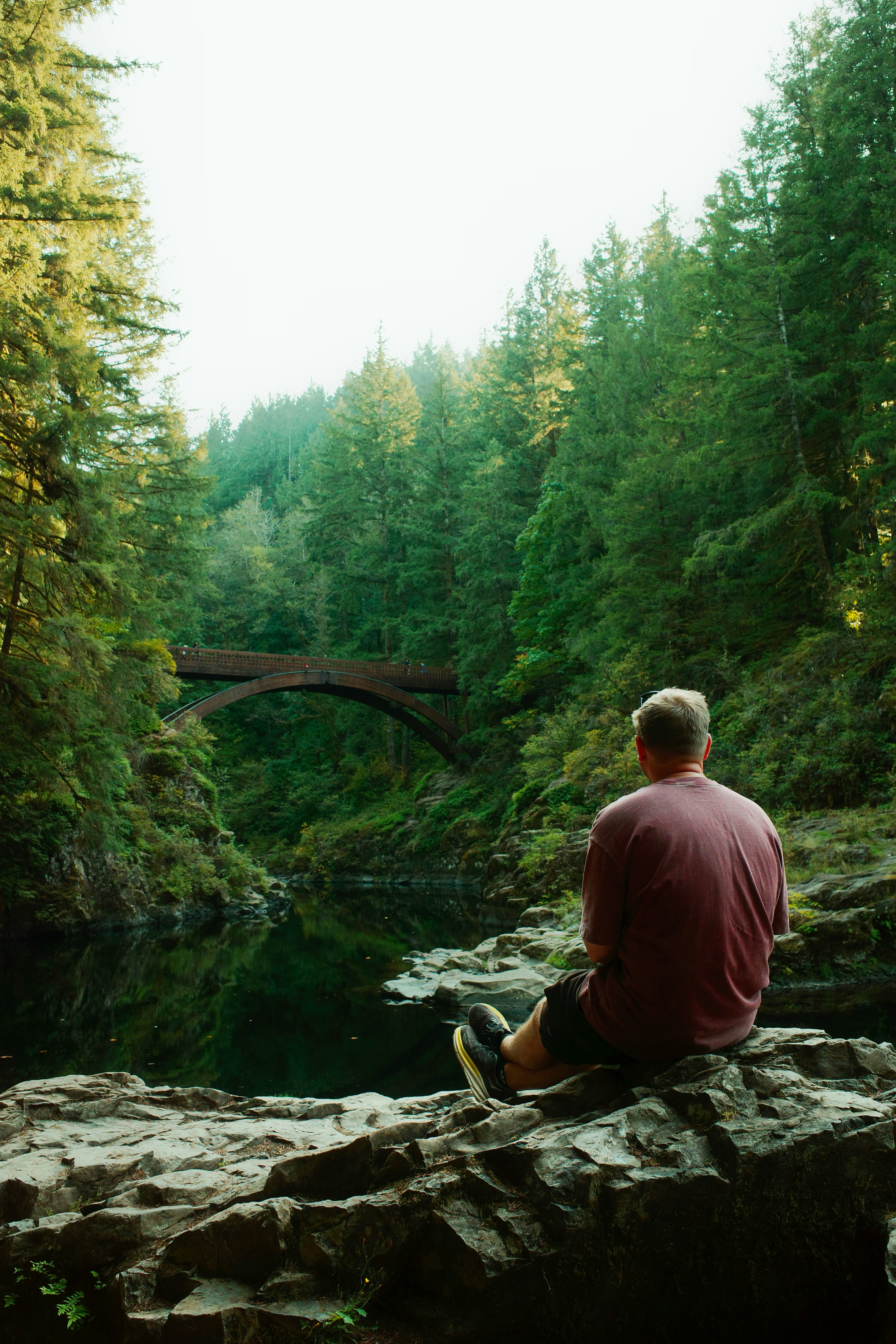 Riverside Rest: A Solitary Moment by the Stone Threshold
