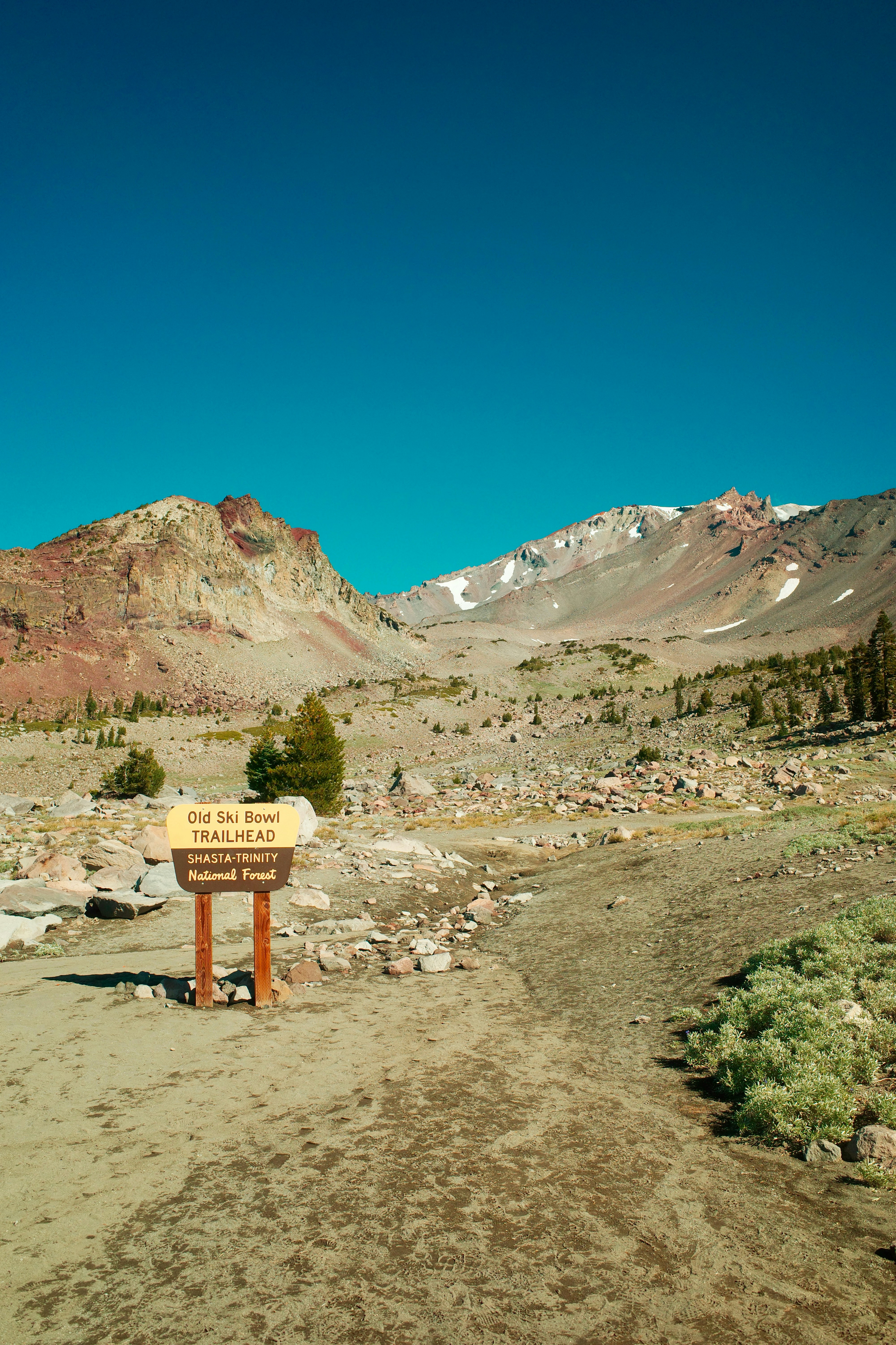 Trailhead to Alpine Tones: Old Ski Bowl Sign Amidst Colorful Peaks