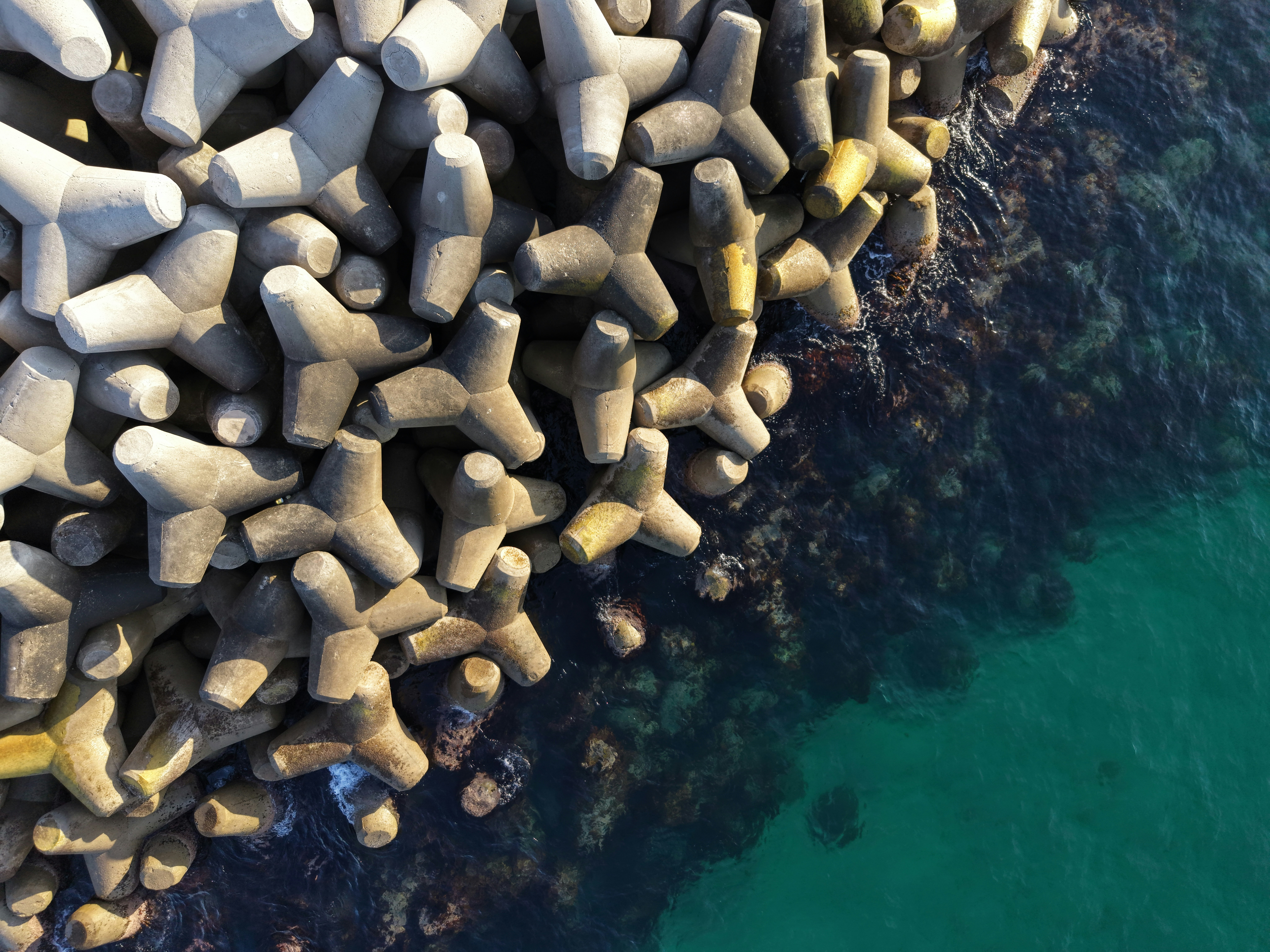 Concrete Breakwaters Framing the Turquoise Sea