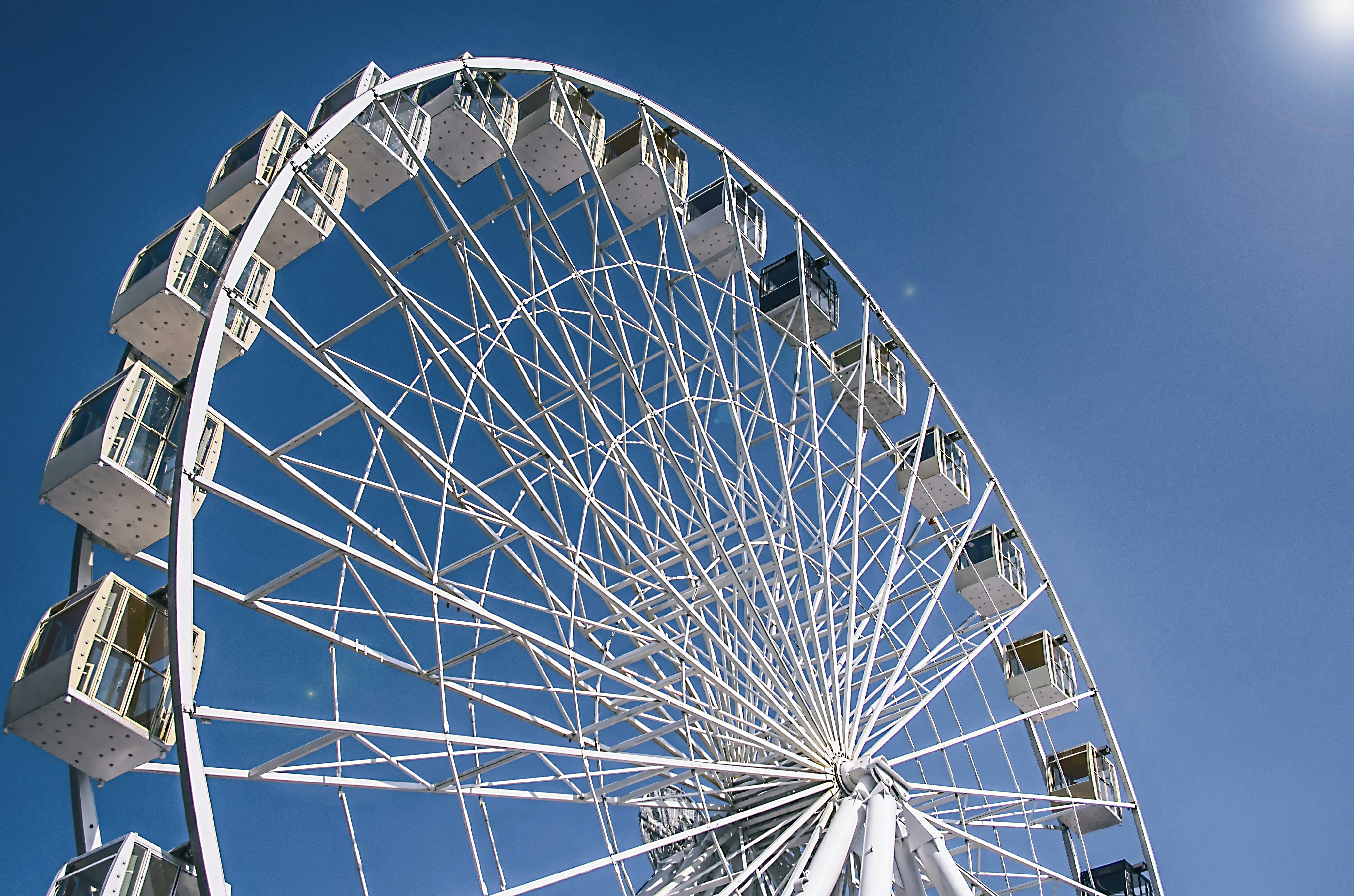 Skyward Circulation: The White Wheel Reaching into a Brilliant Blue