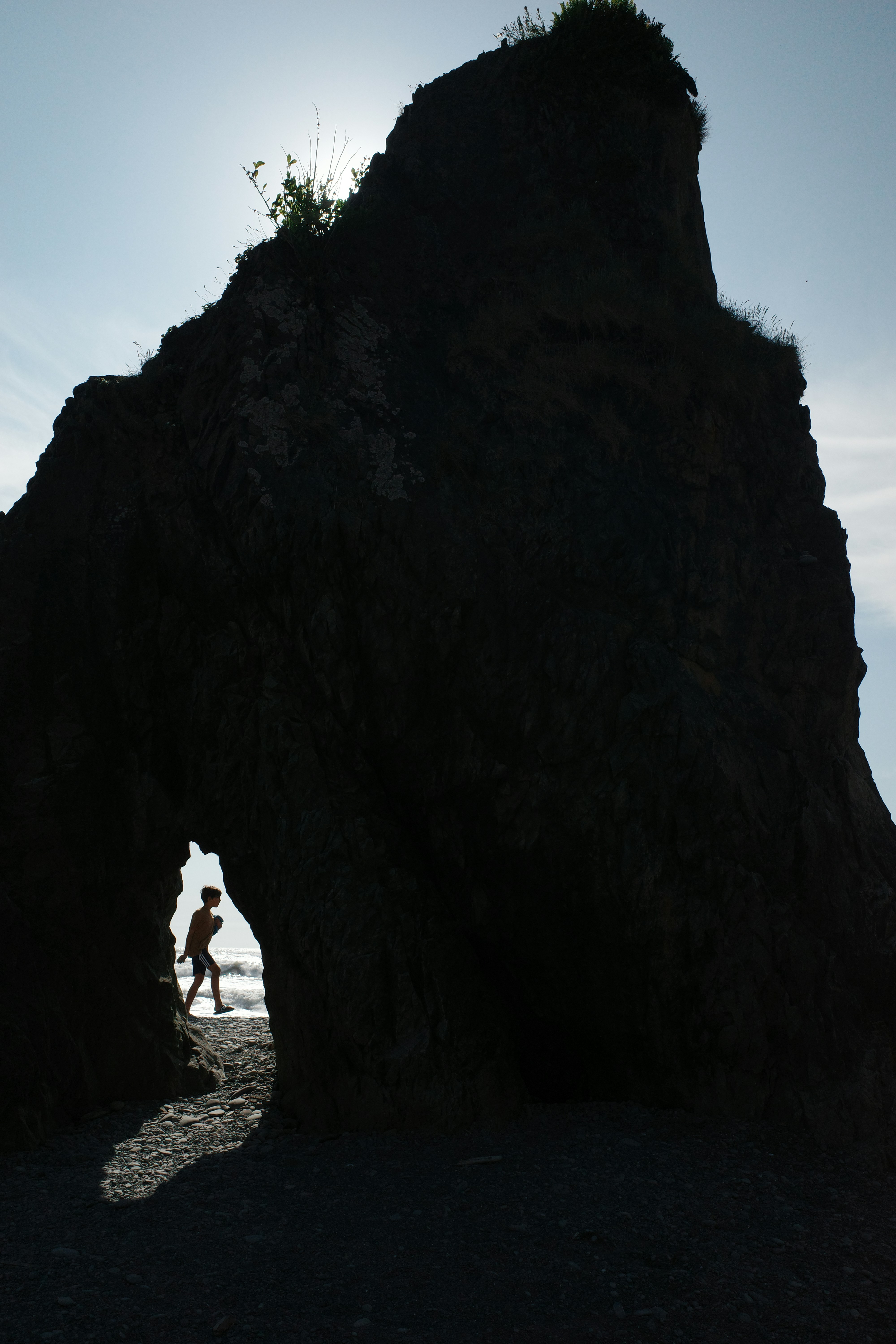 Silhouette Through a Sea-Arch: A Lone Runner in the Light