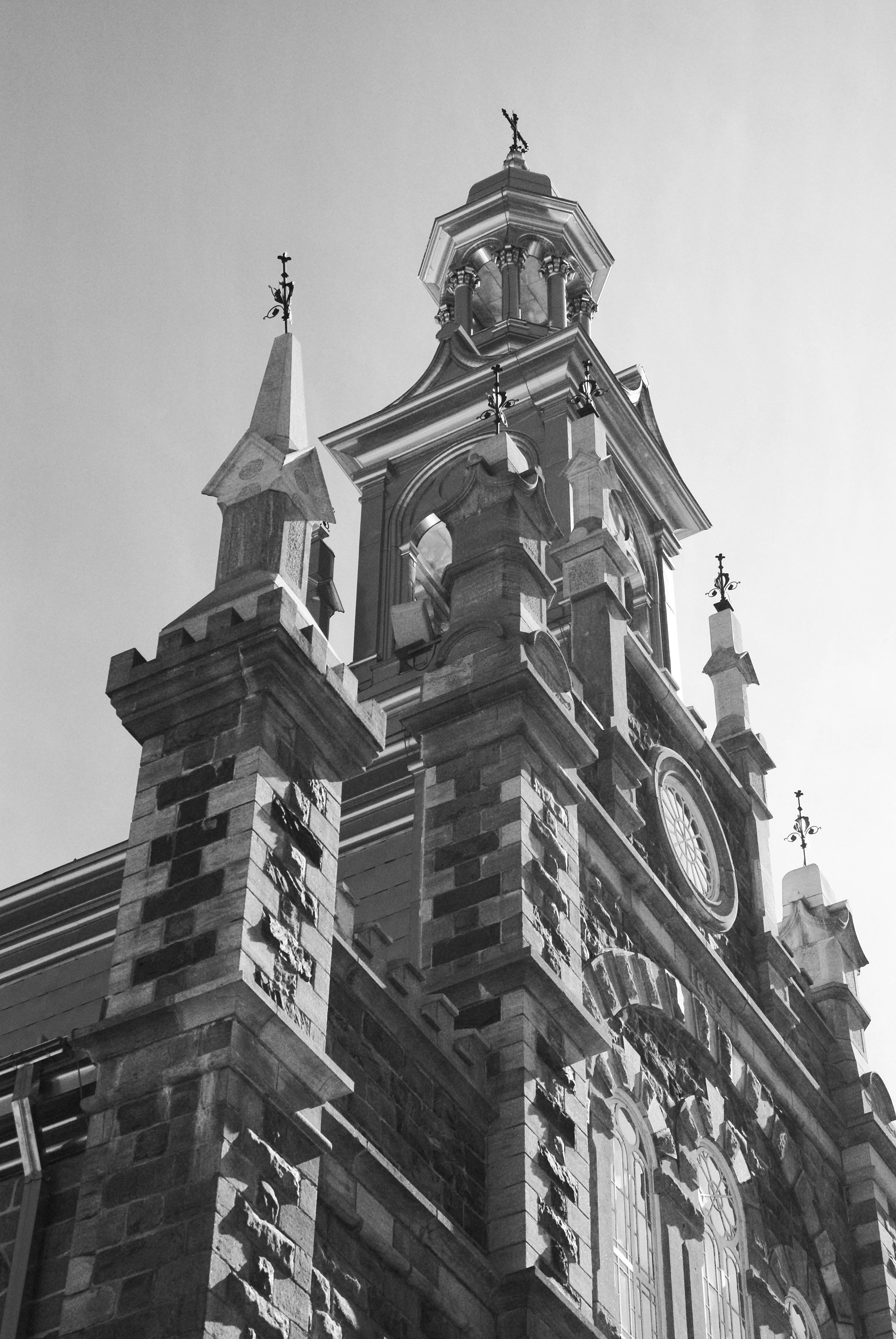 Gothic Clocktower Ascending: A Monumental Facade in Sunlit Stone