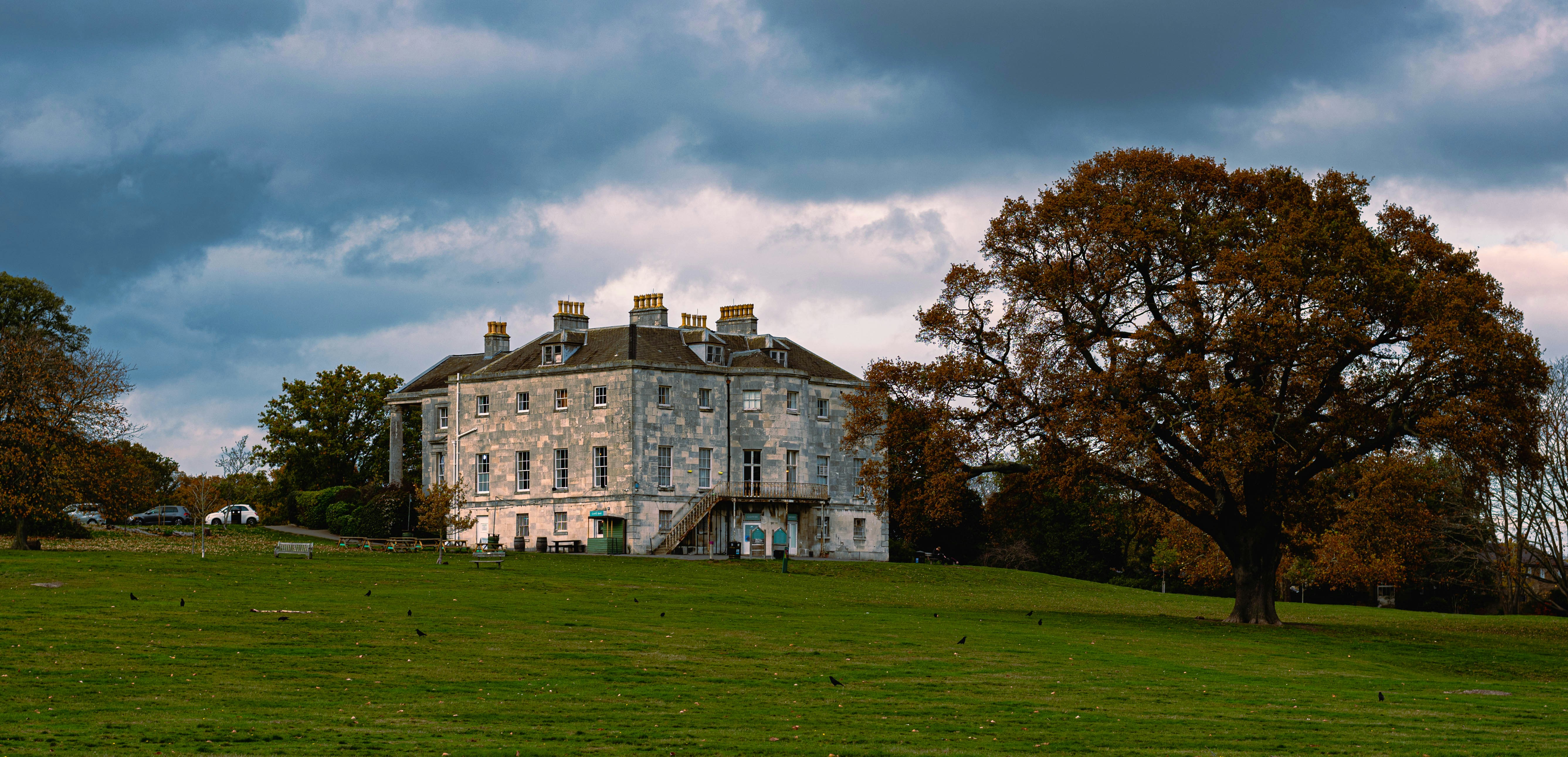 Stone Manor on a Rolling Moor under Autumn Sky