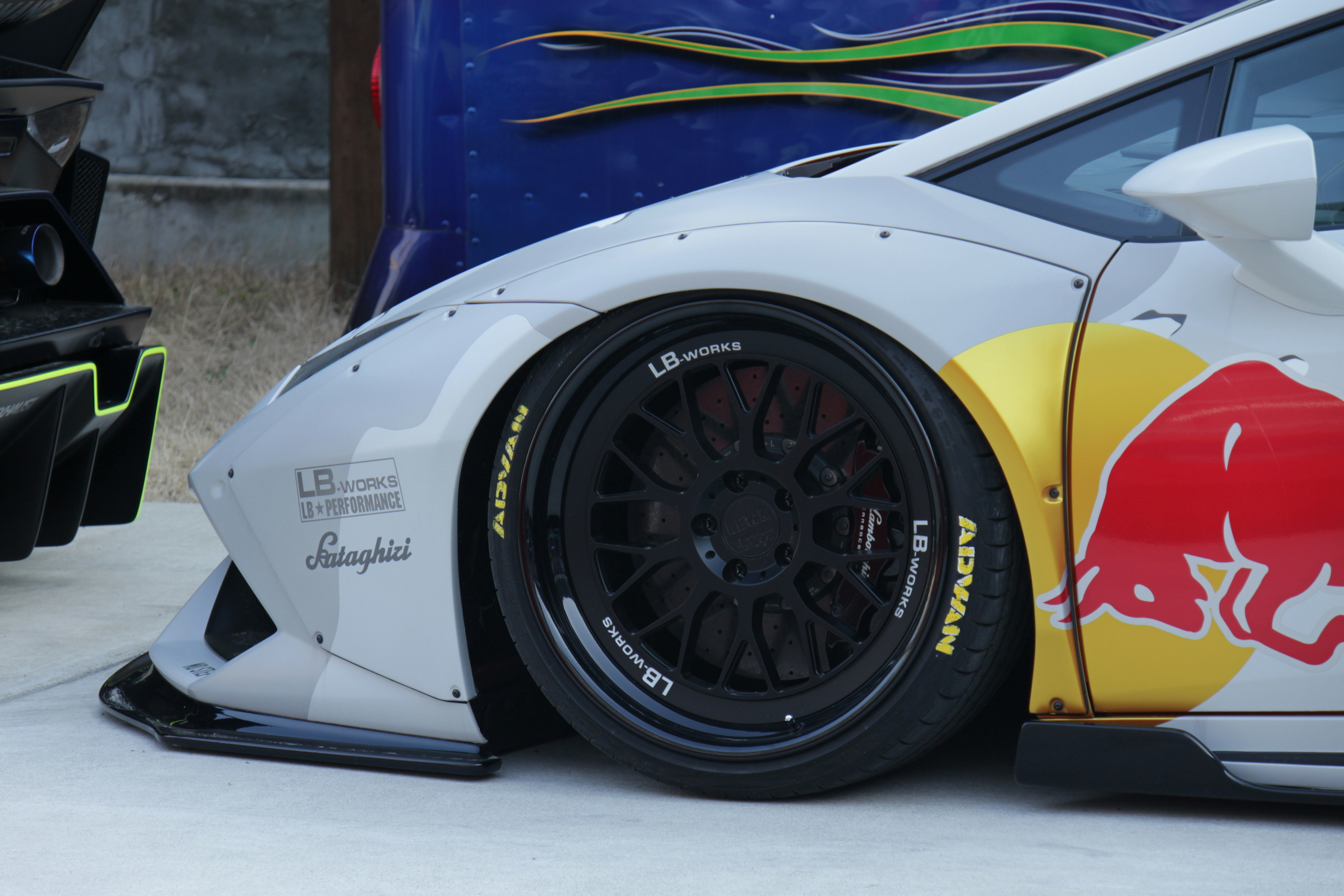 Front Wheel, Flame-Graphic Momentum: A Race Car Corner in Focus