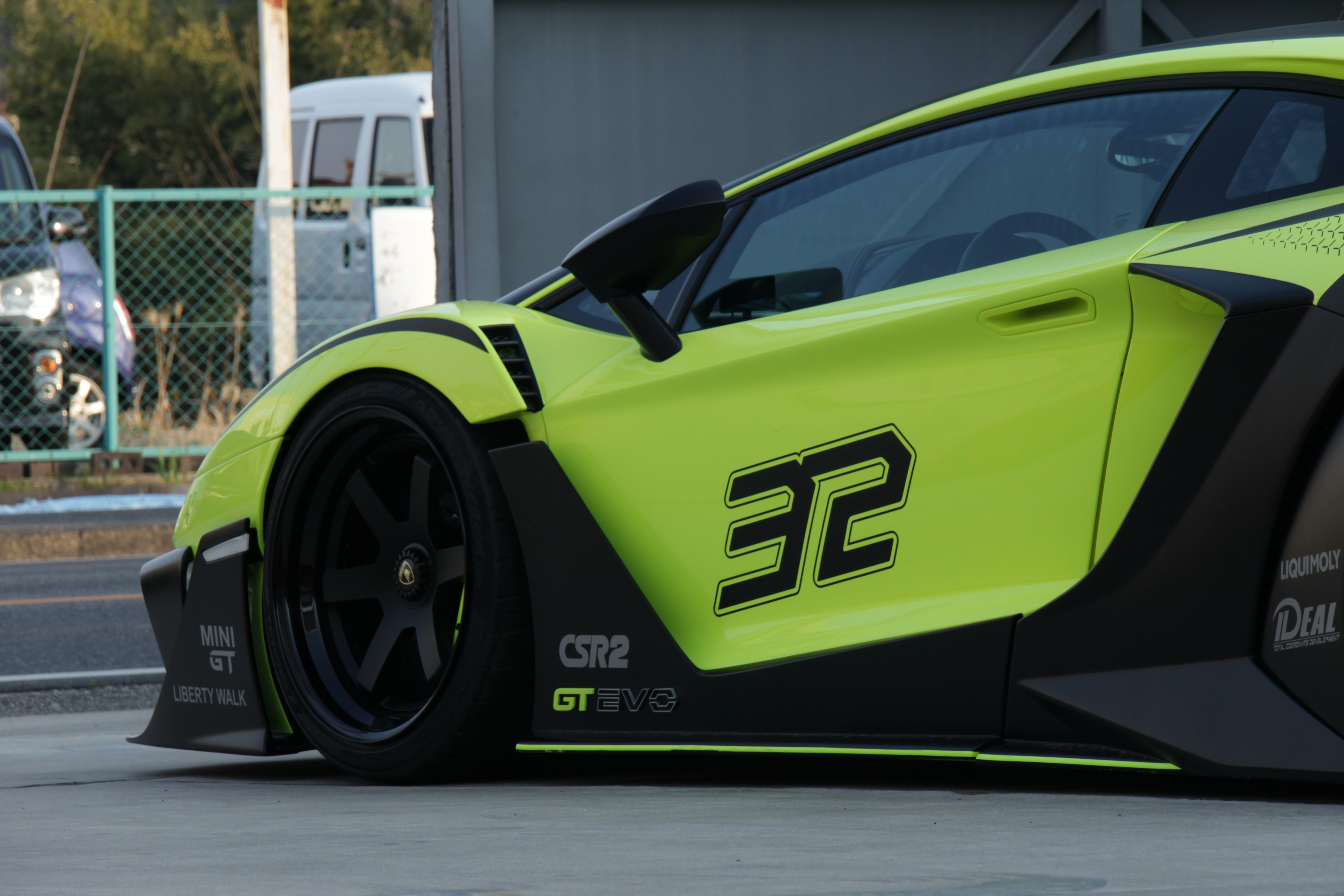 Lime Livery: A Sleek Green Racecar Lays Slow at the Track