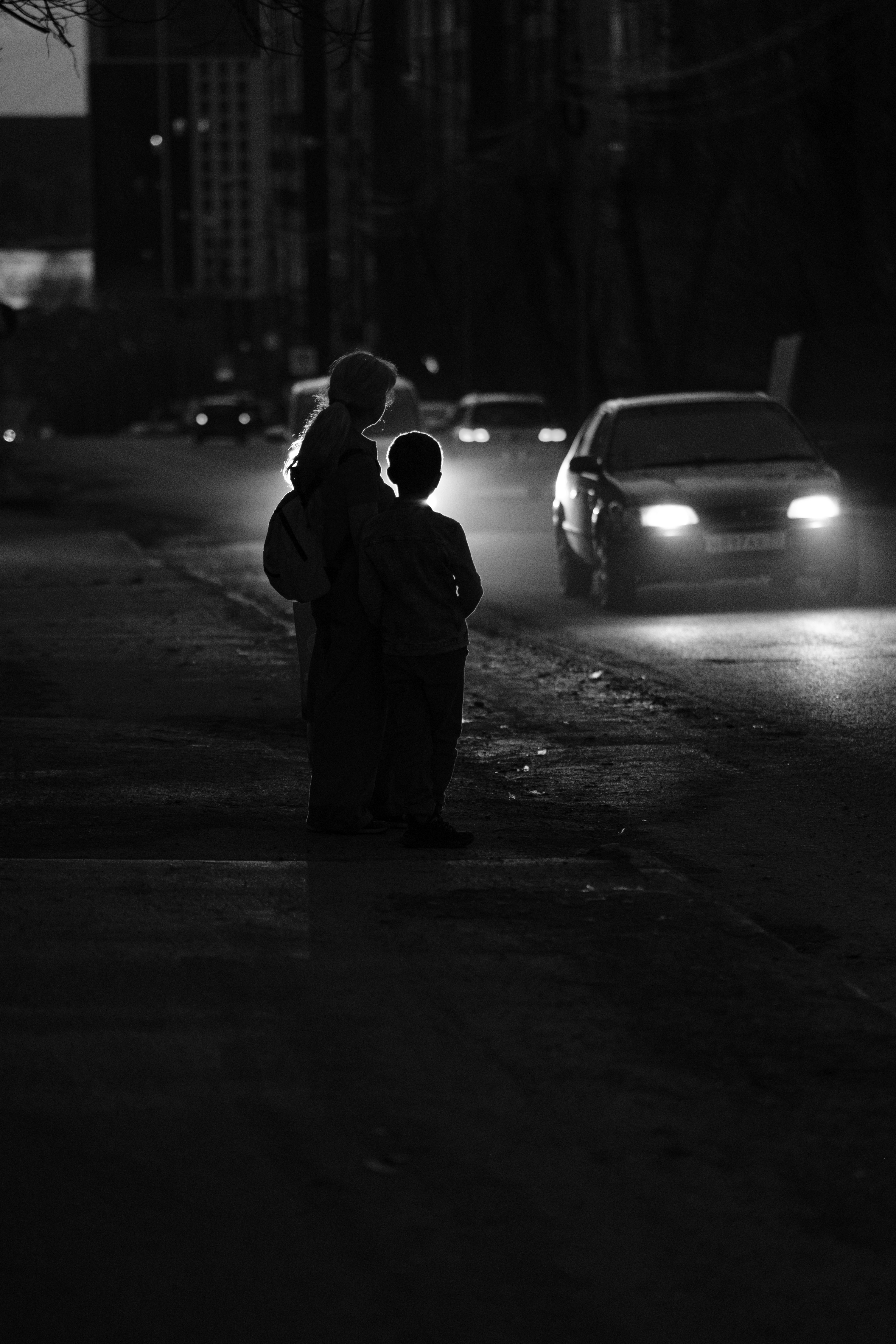 Nighttime Embrace: A Quiet Moment on a Dim Street