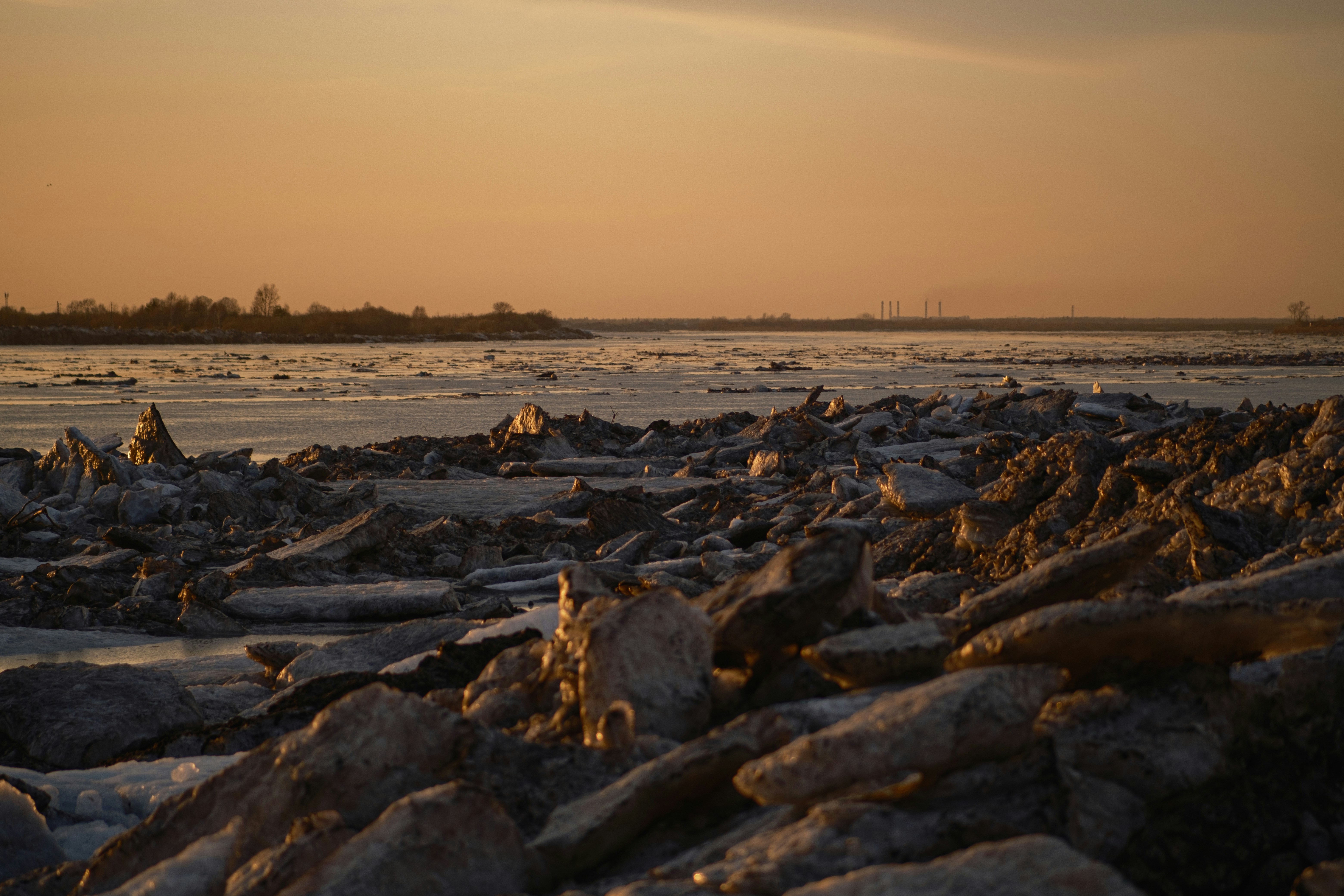 Dawn on the Shallow Delta: Rugged Rocks Meet a Quiet Horizon