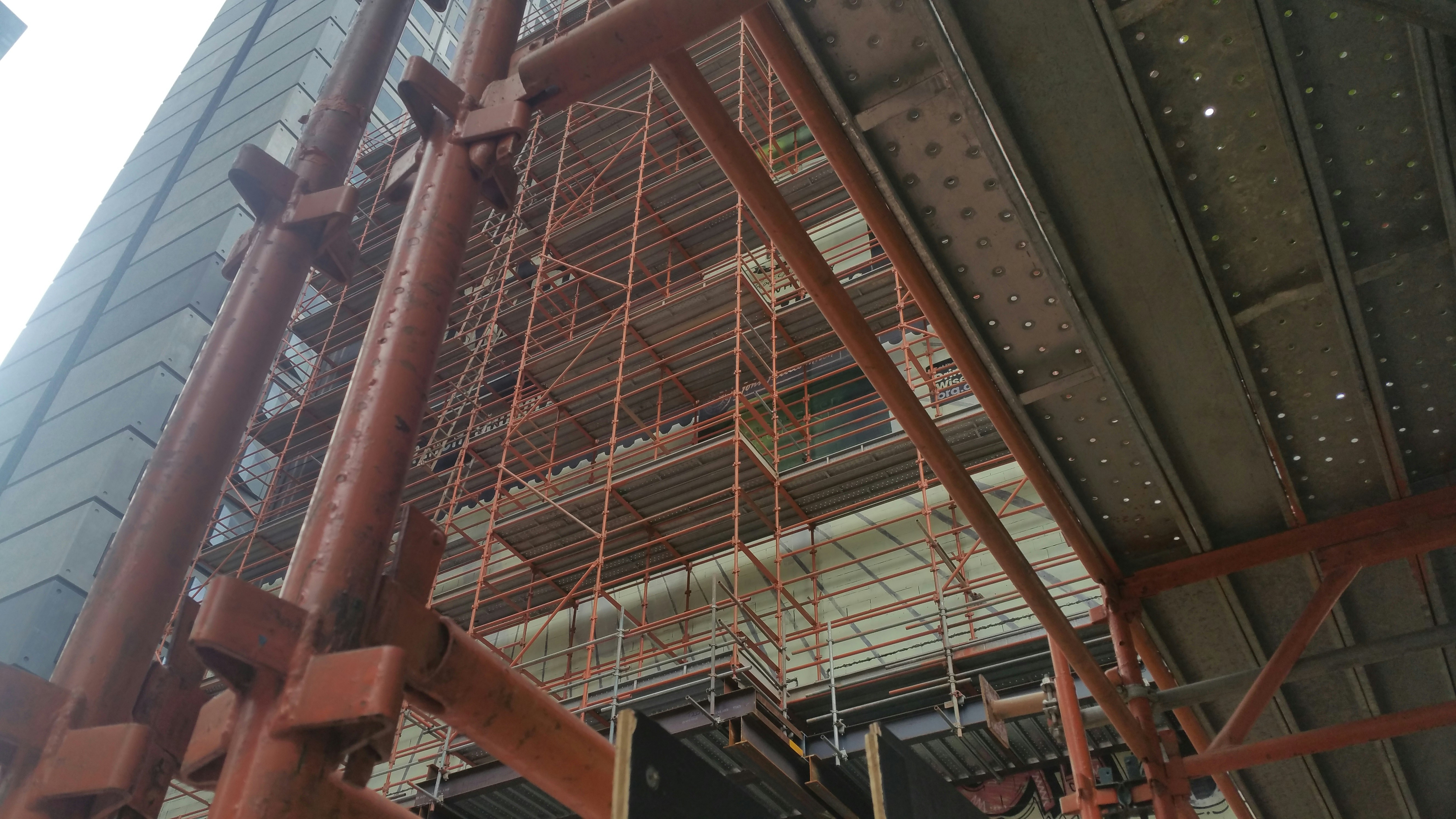 Crisscross of Red: Construction Scaffold in Urban Glow