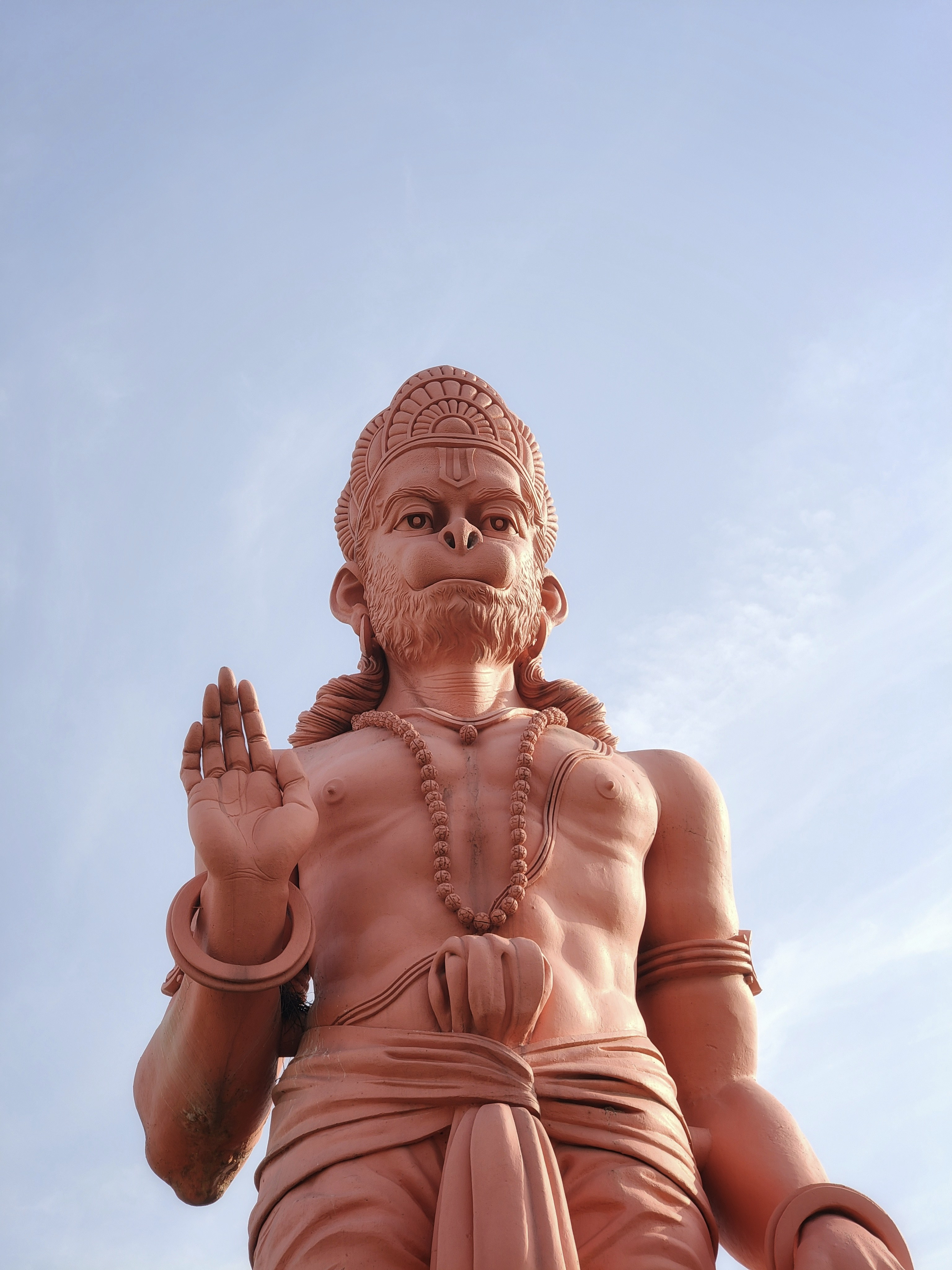 Monumental Hand-Raised Greeting Beneath Open Sky