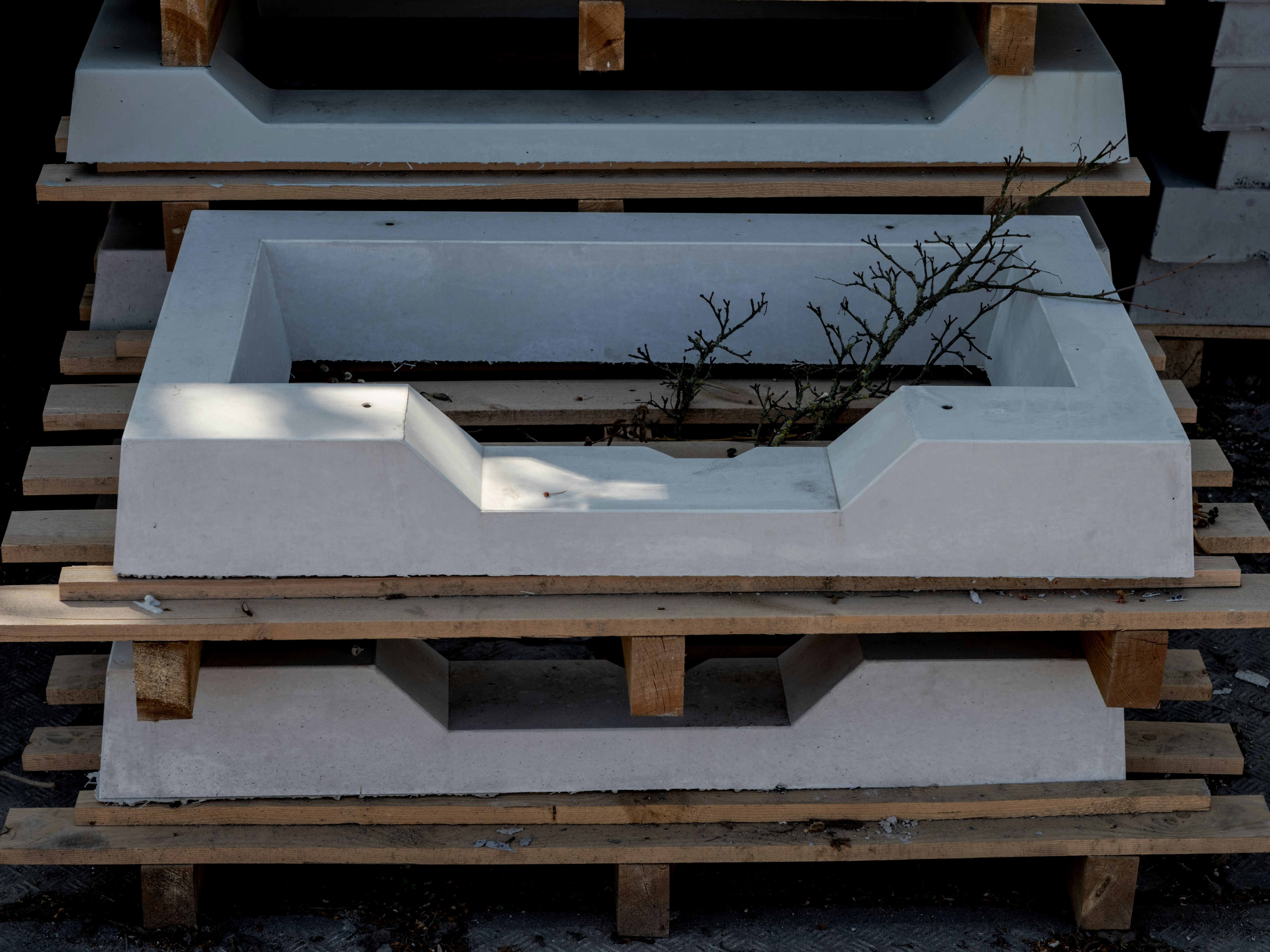 Concrete Stepbed with Reclaimed Wood Pallets and a Spindly Branch