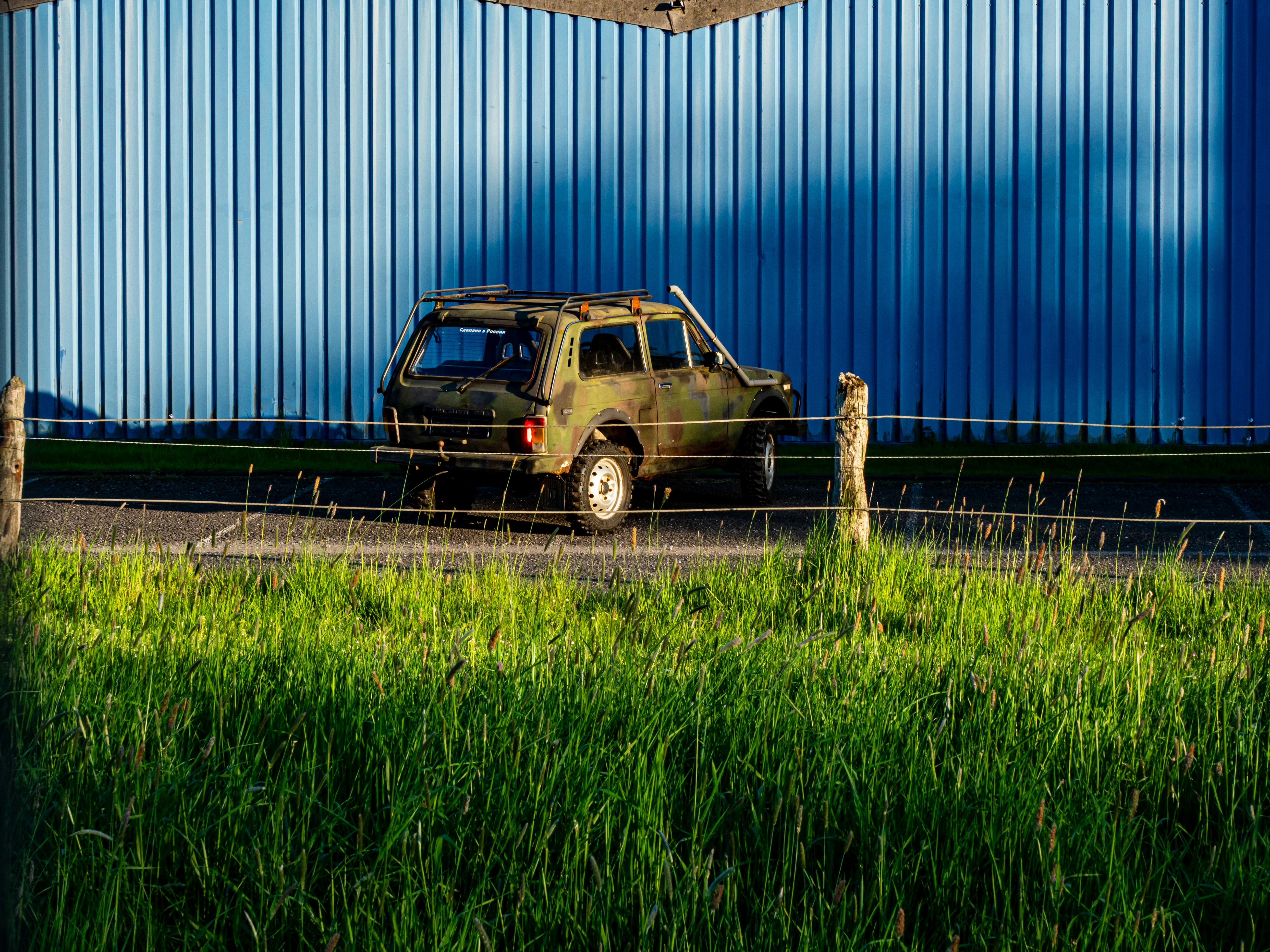 Weathered Suzuki on a Fence-Line Horizon