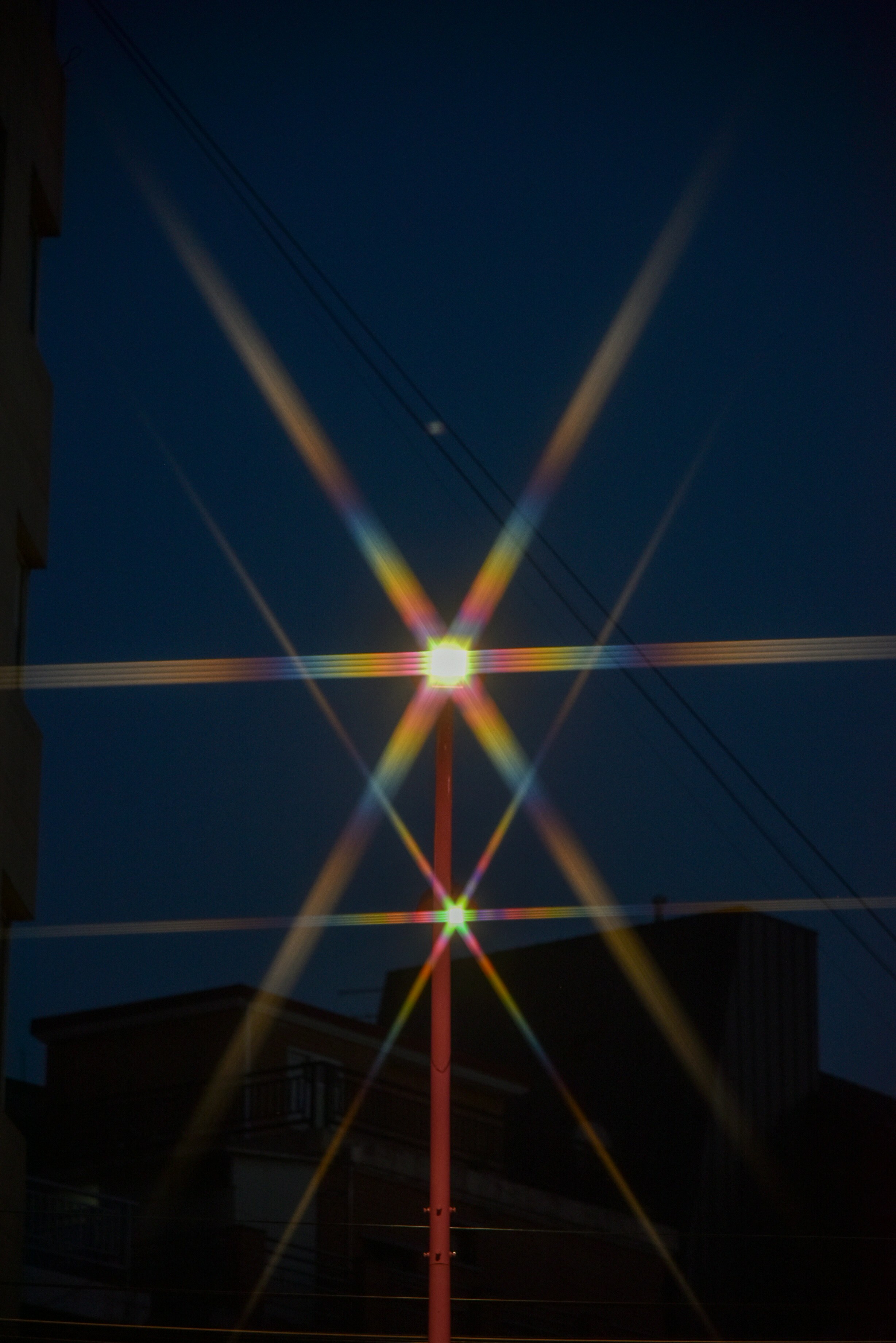 Crosshairs of Light: Urban Night Stars in a Quiet Street