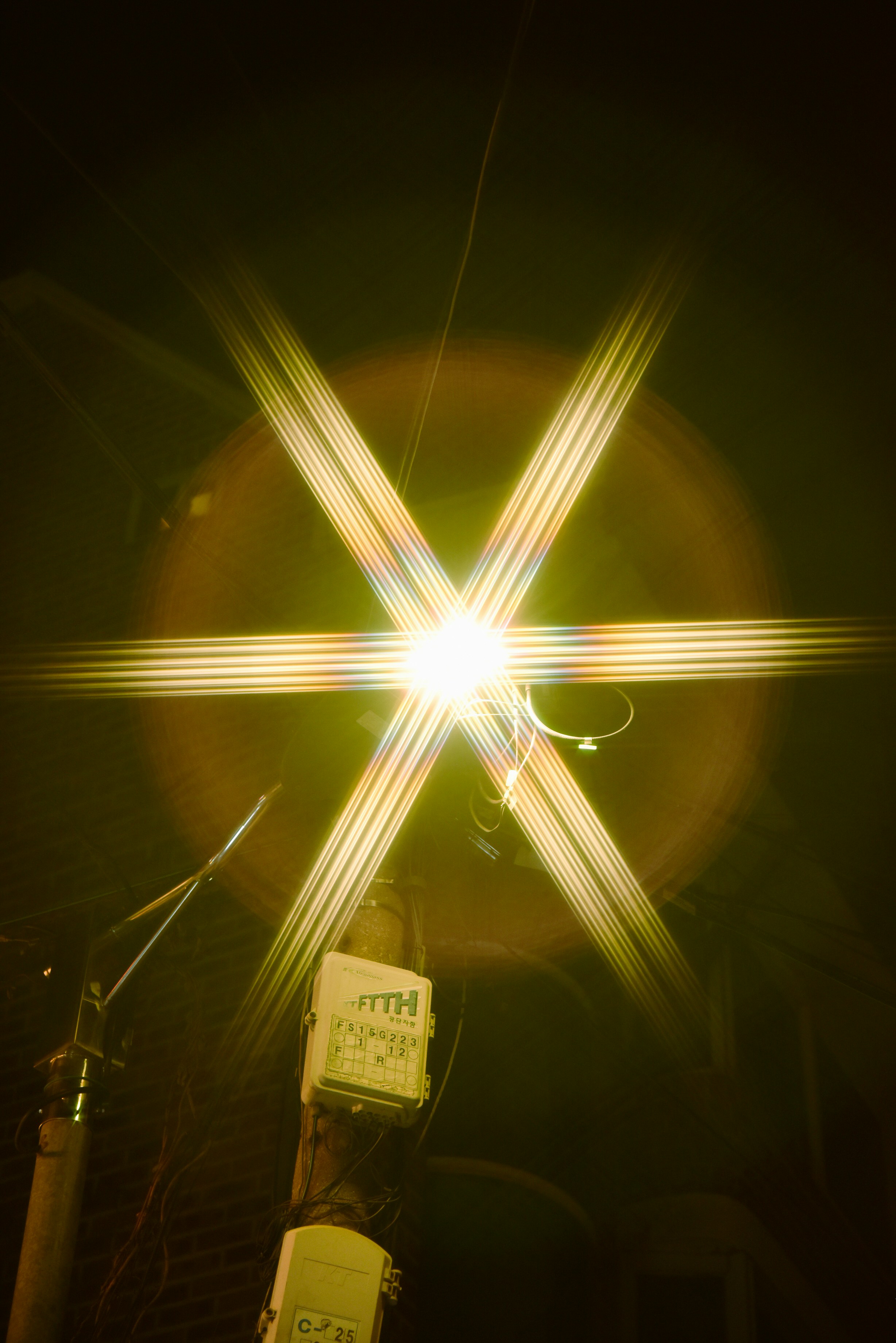 X-shaped Burst: Neon Cross at the Lamp Post