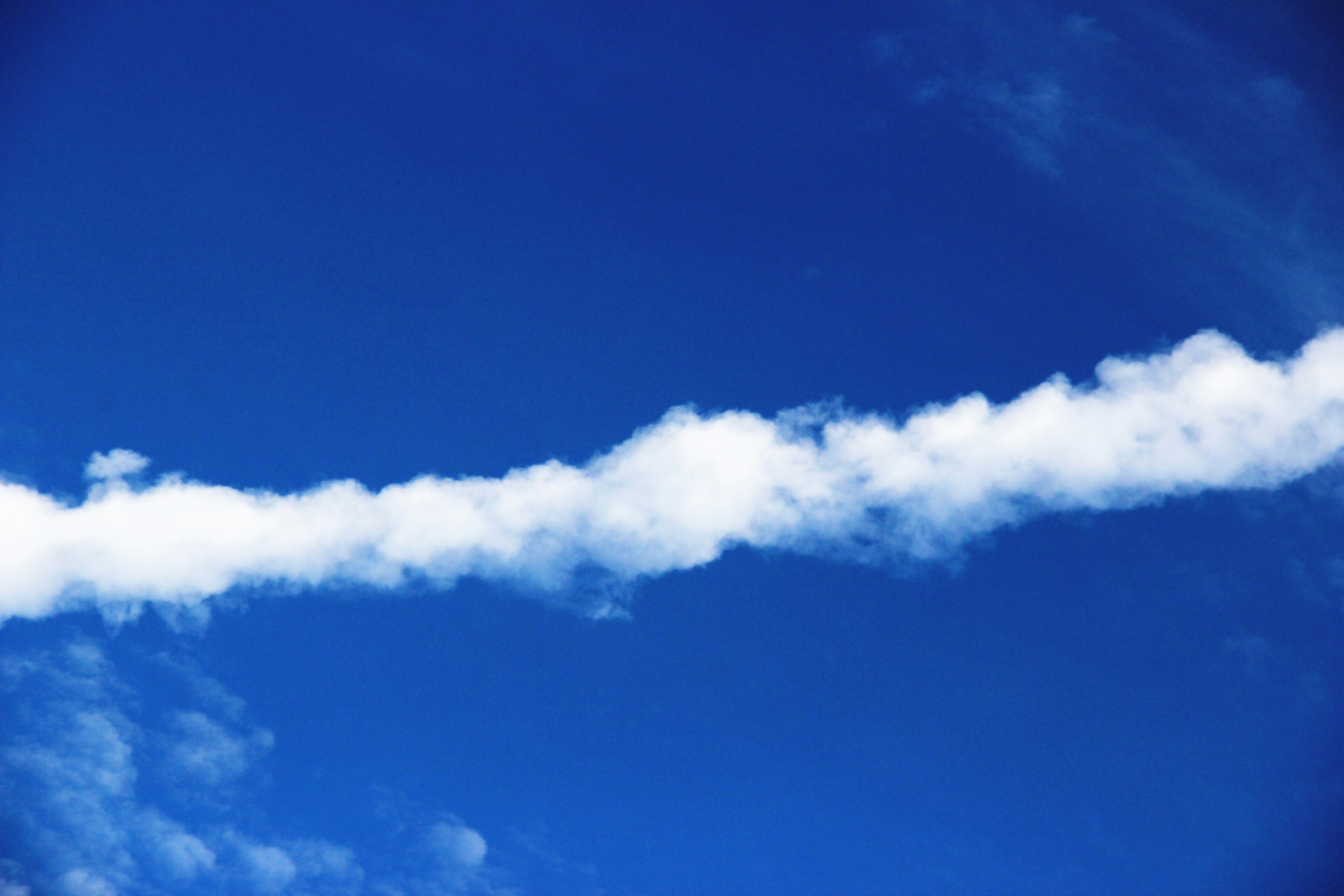 A Stray Whisper of Cloud Across a Pristine Blue Canopy