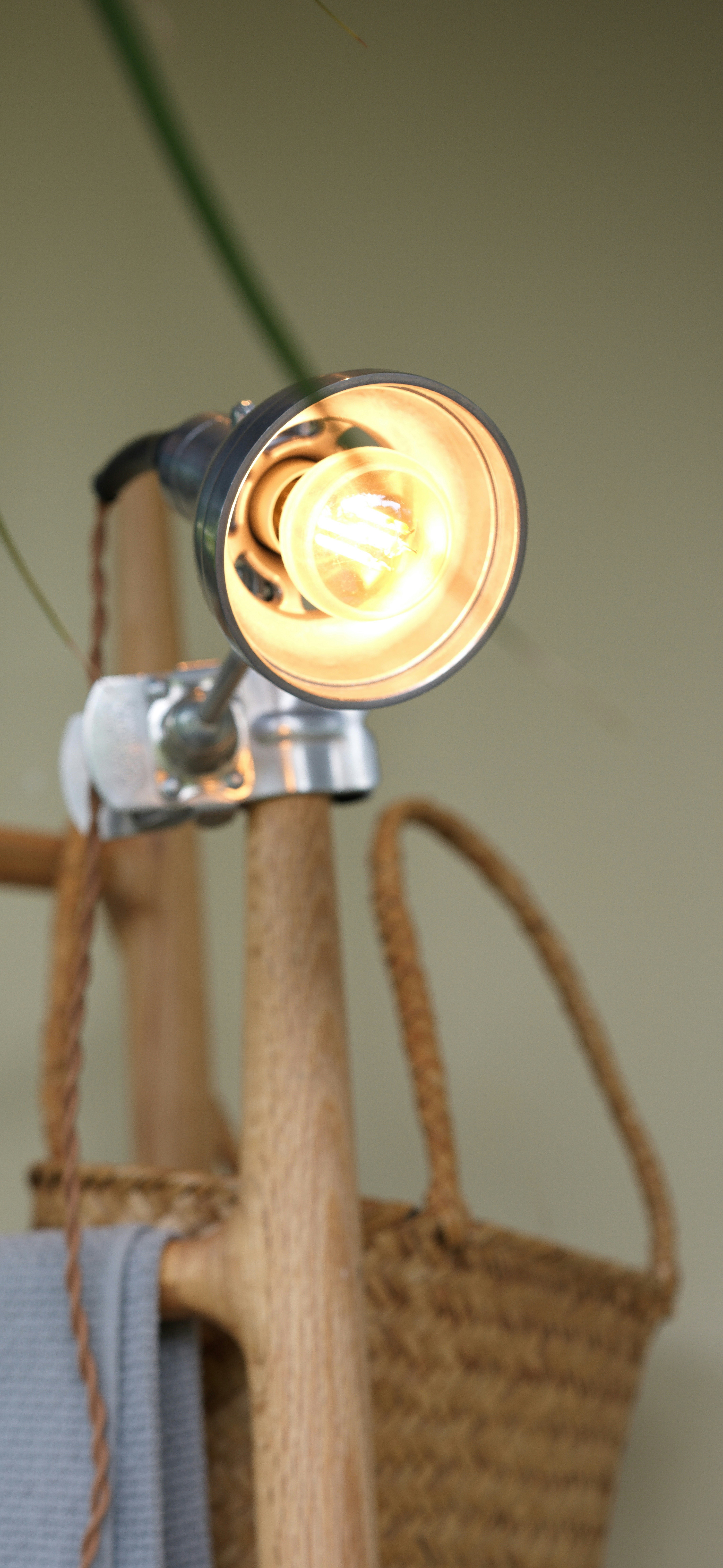 Liquified glow: a vintage spotlight on a wooden tripod