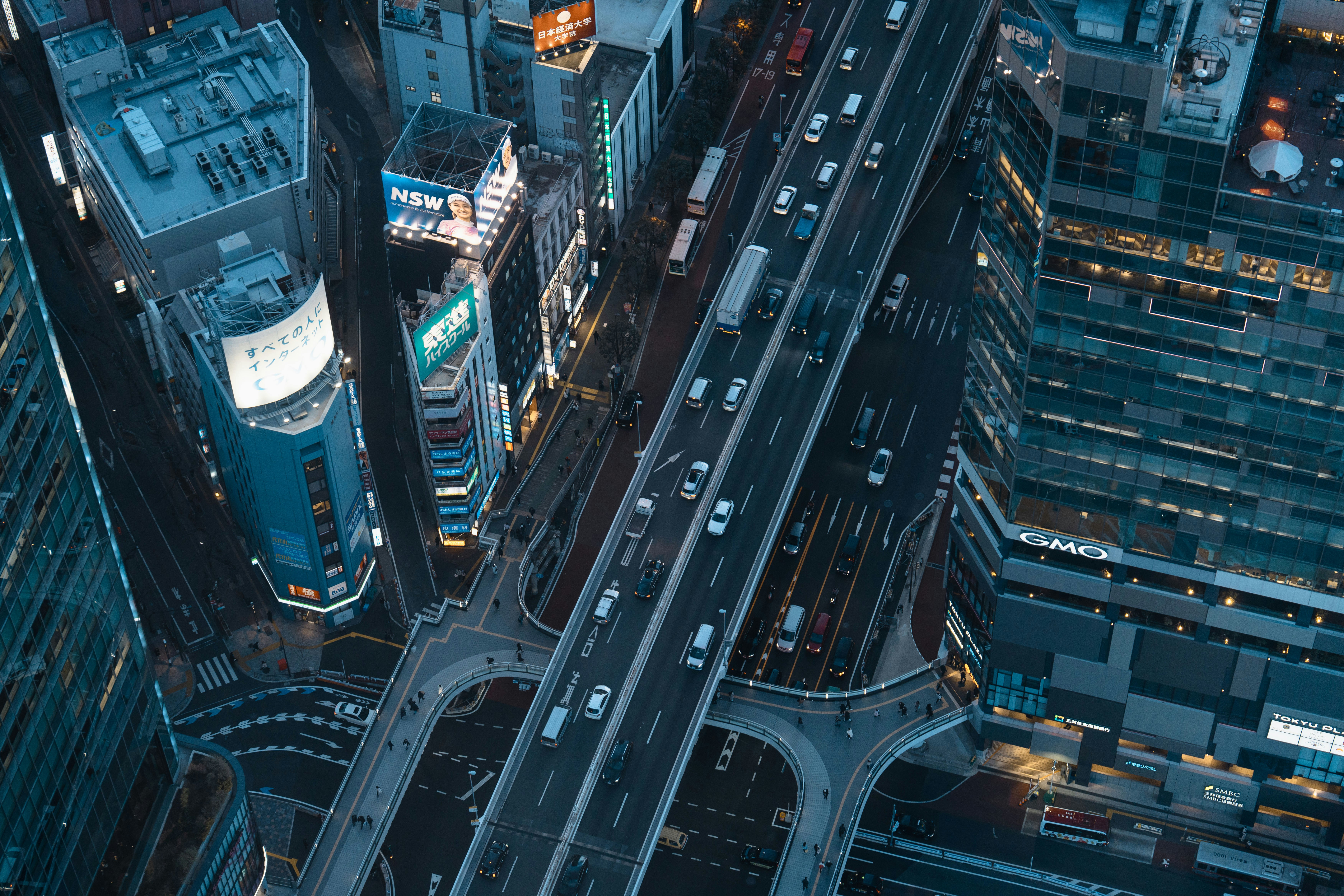 Aerial Convergence: Neon Artery Carves Through the City