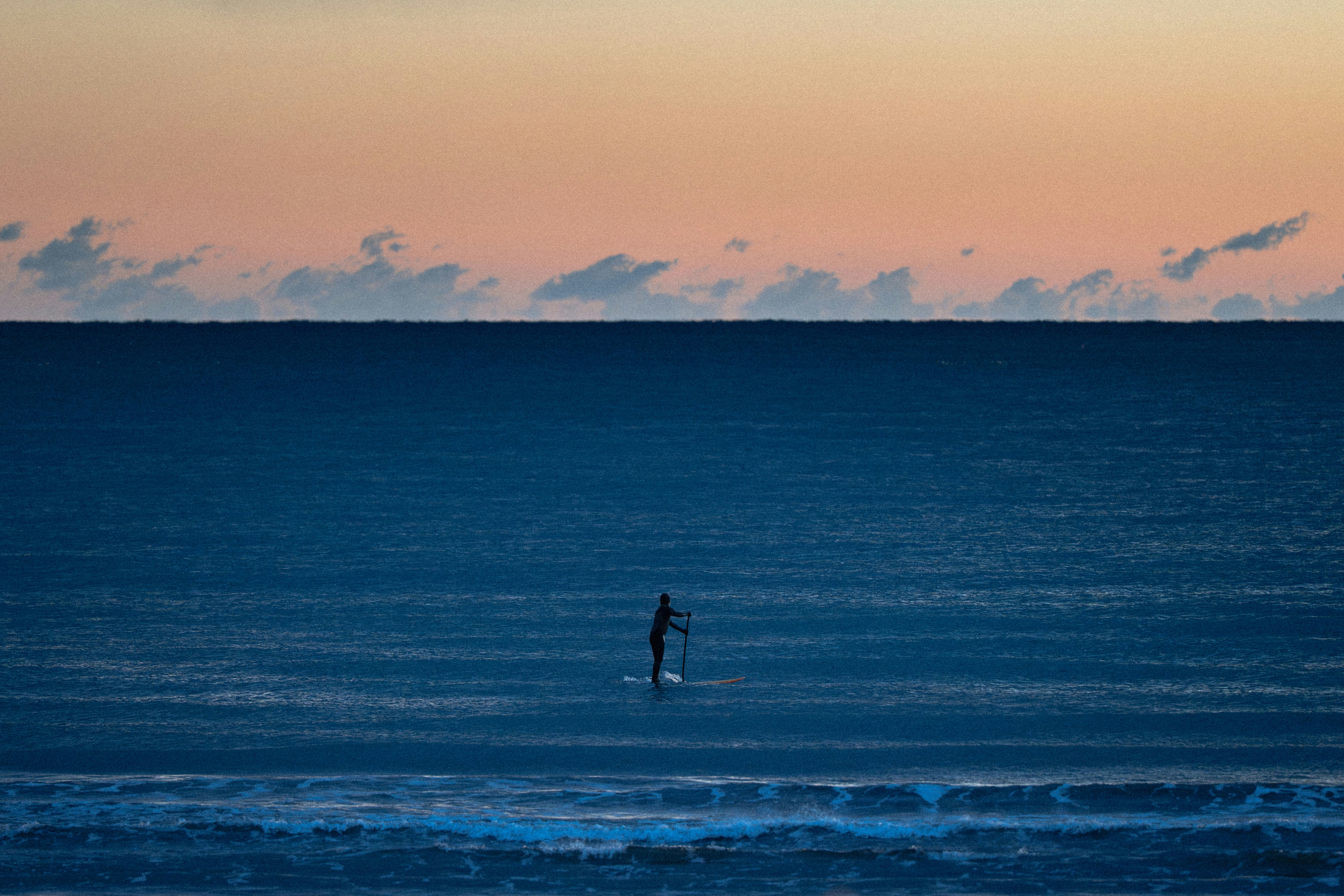 Solitary Surfer at Dusk: A Quiet Horizon
