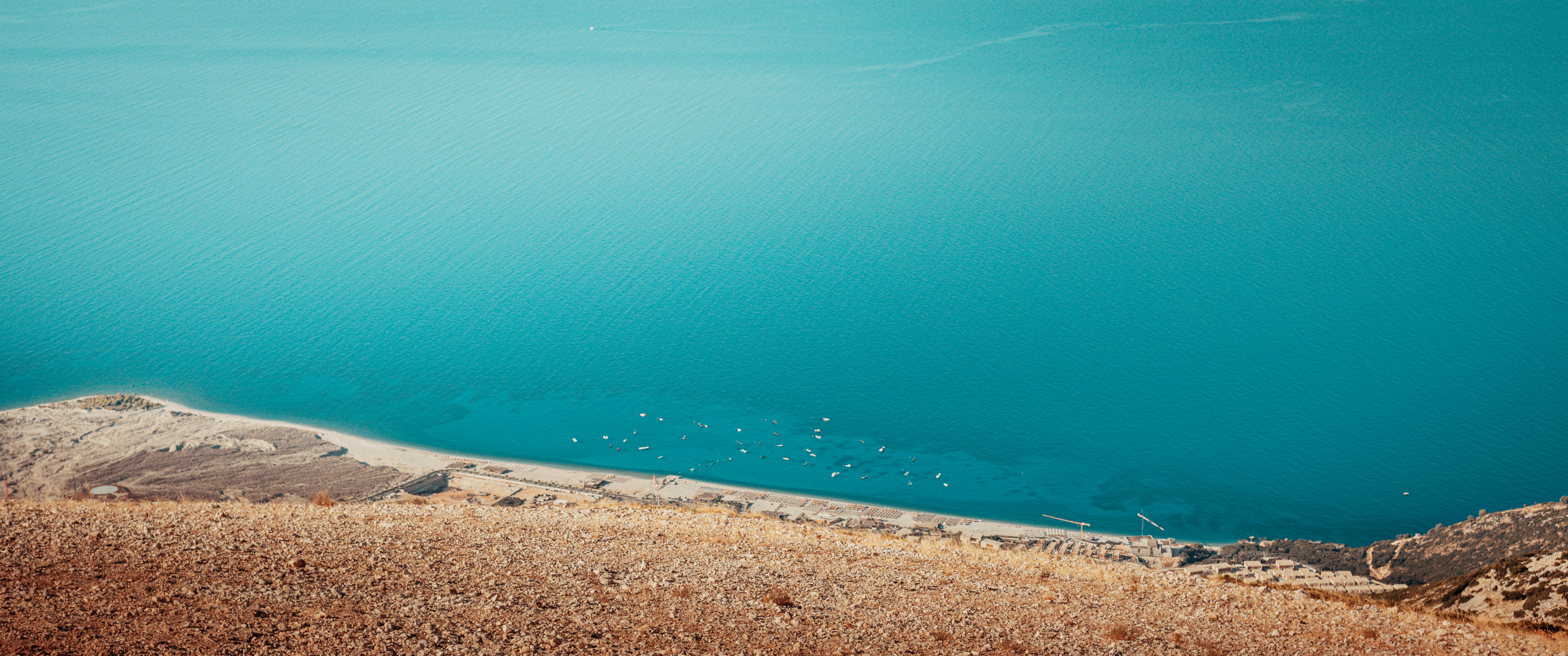 Edge of Serene Blue: A Desert Shoreline Meeting a Quiet Sea
