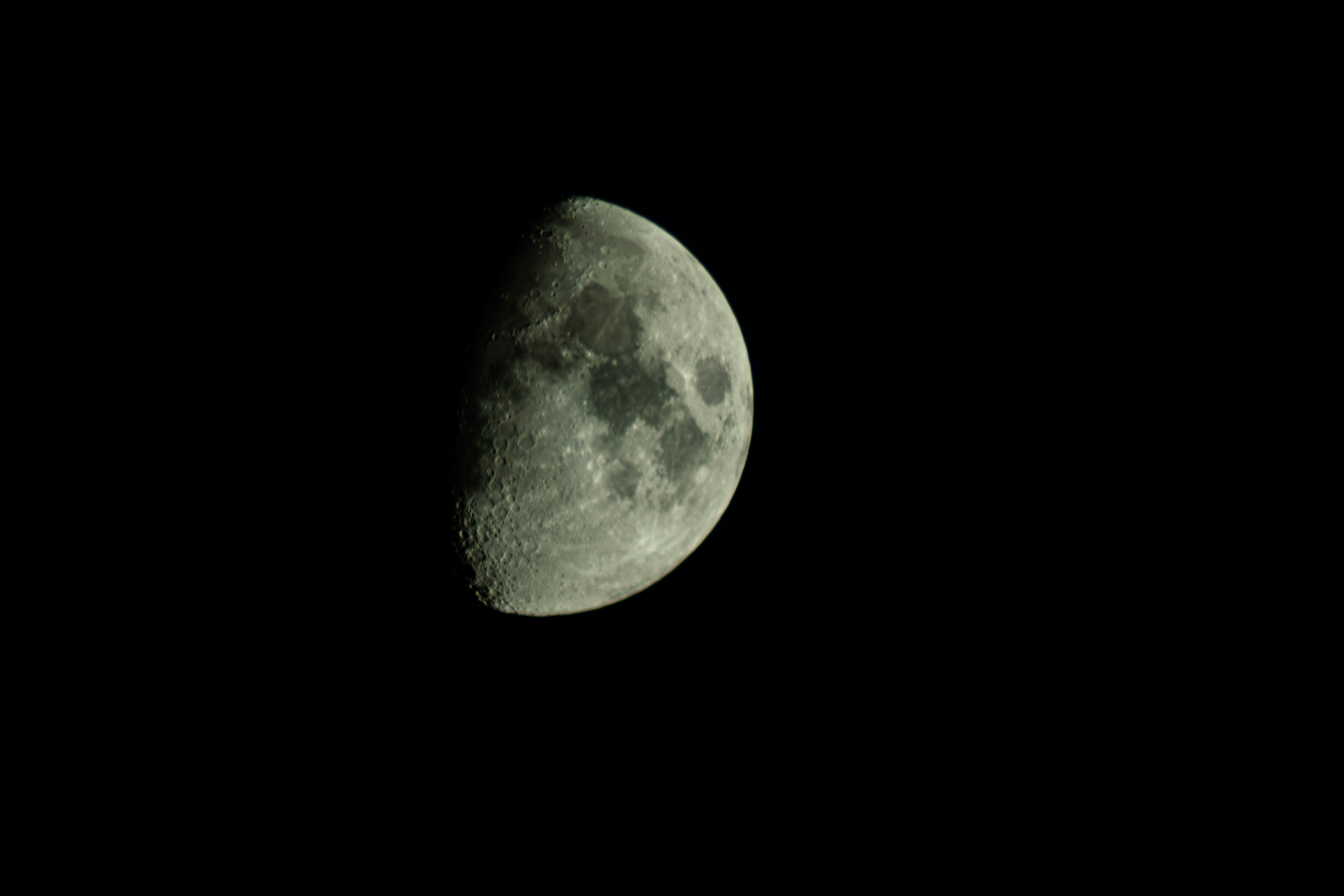Lone Crescent: Moonlit Ivory on a Dark Canvas