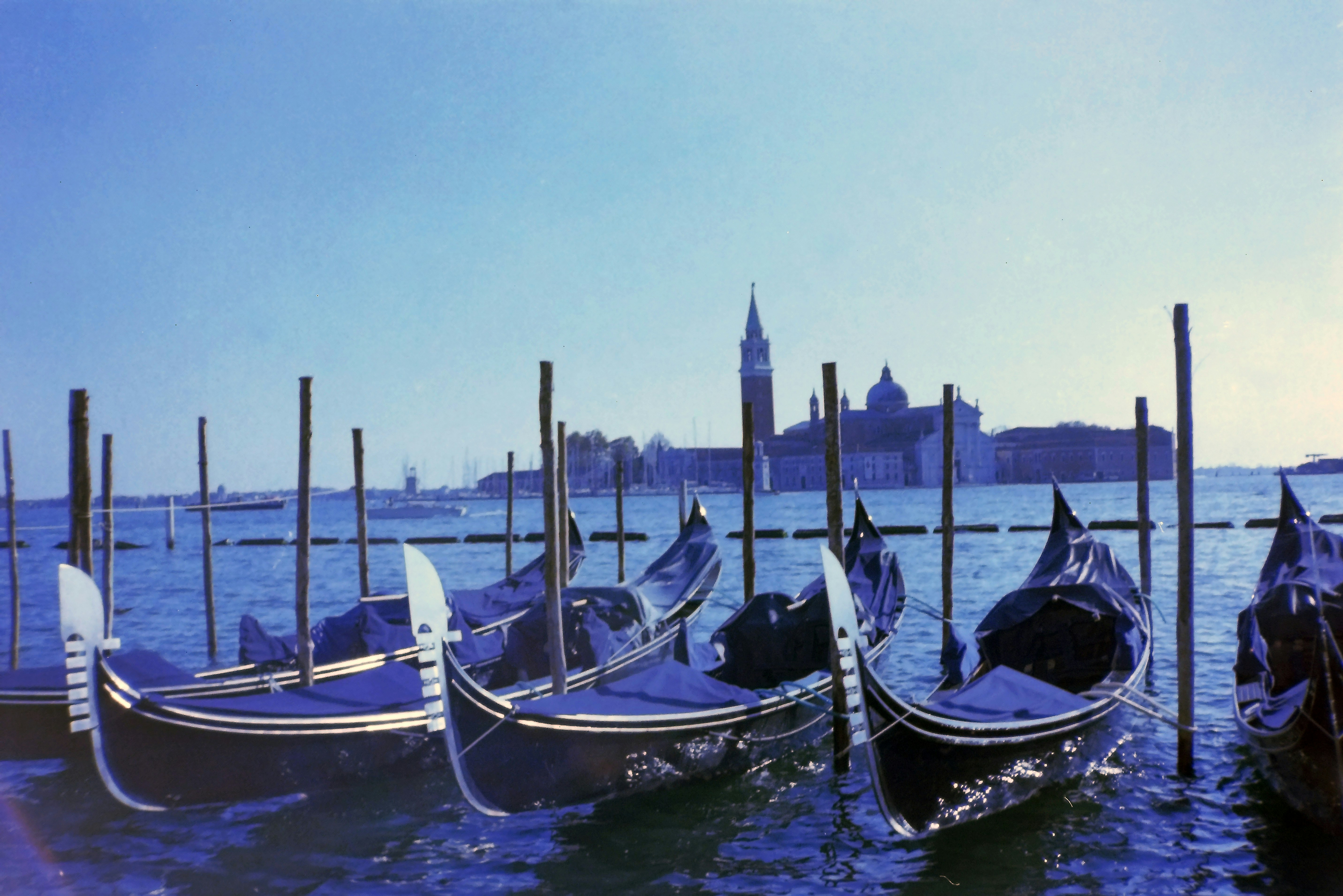 Gondolas at Dusk: Gentle Ripples by the Venetian Pier