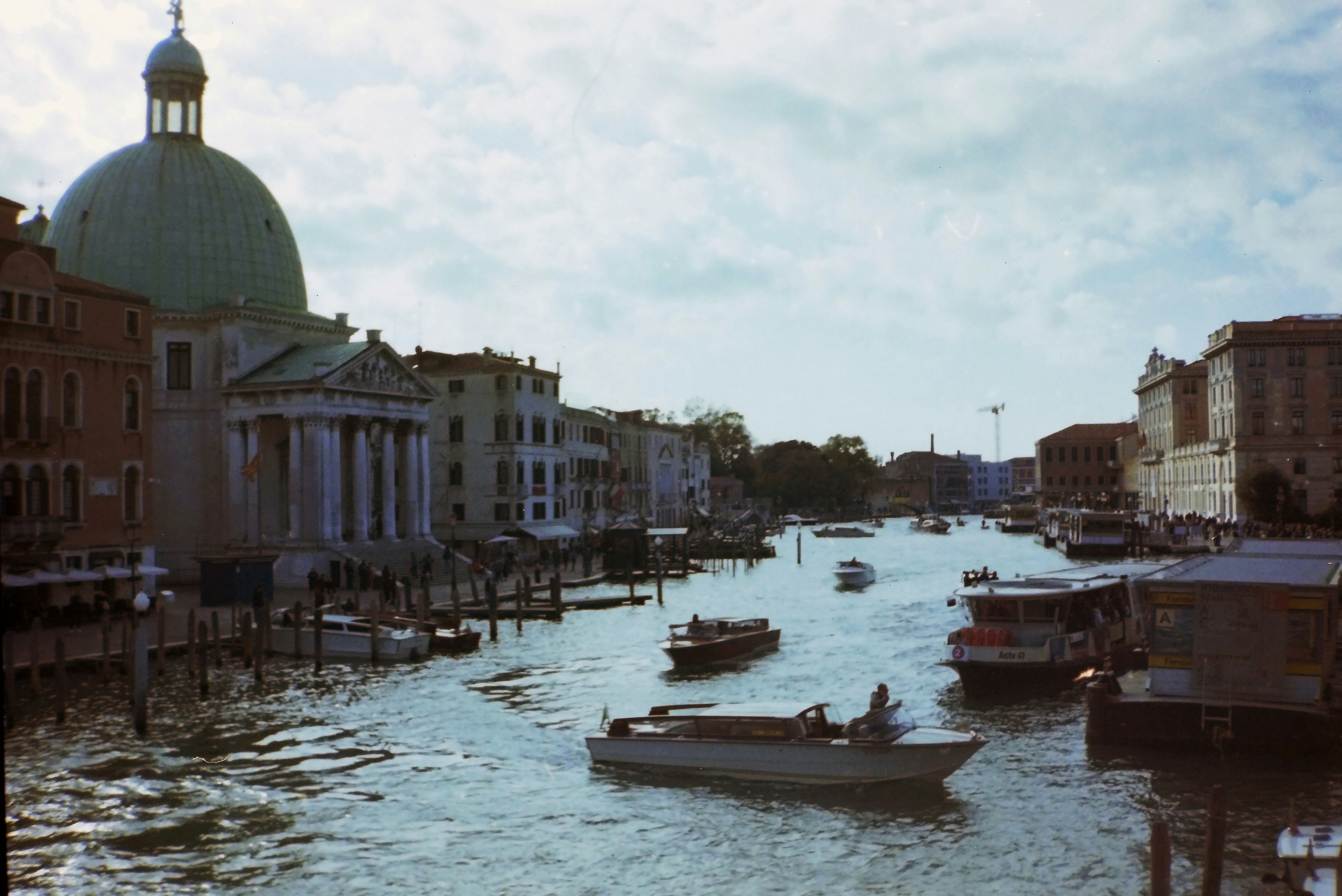 Venetian Channel: Boats, Bridge, and Dome Over a Lively Rippling Canal