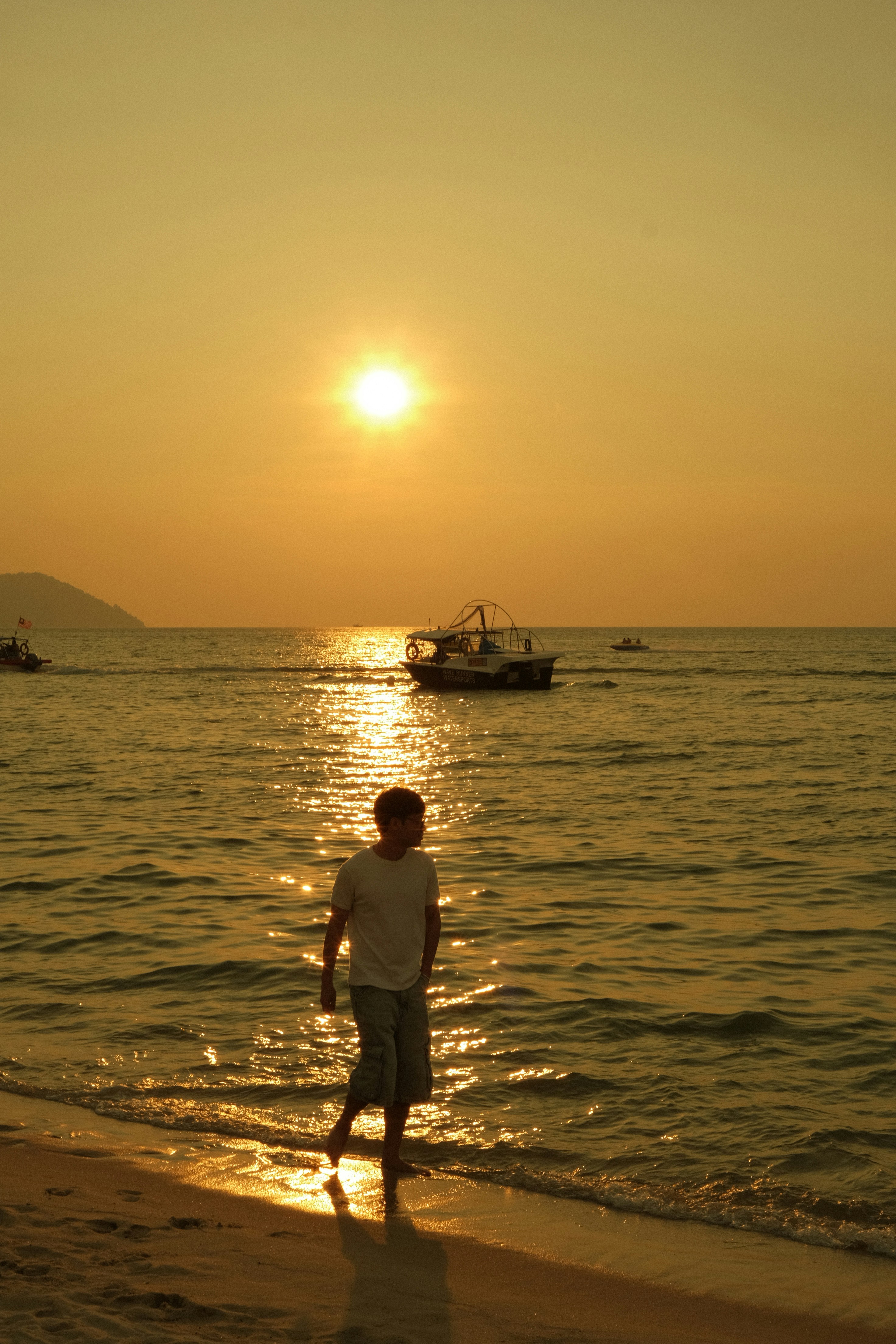 Sunlit stroll at the shoreline as the golden hour settles