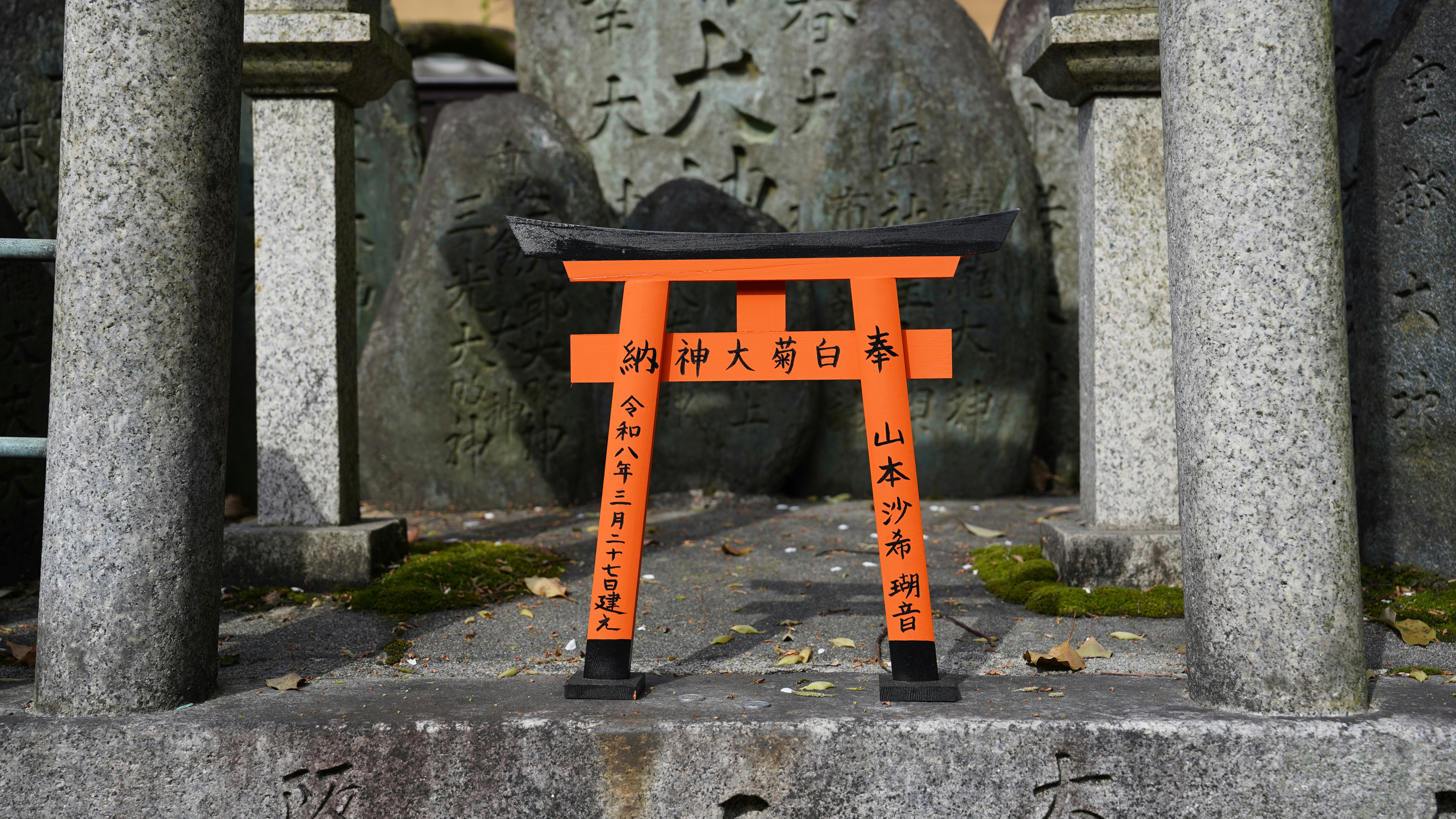 Bright Orange Torii Framed by Weathered Stone: A Shrine Courtyard Moment