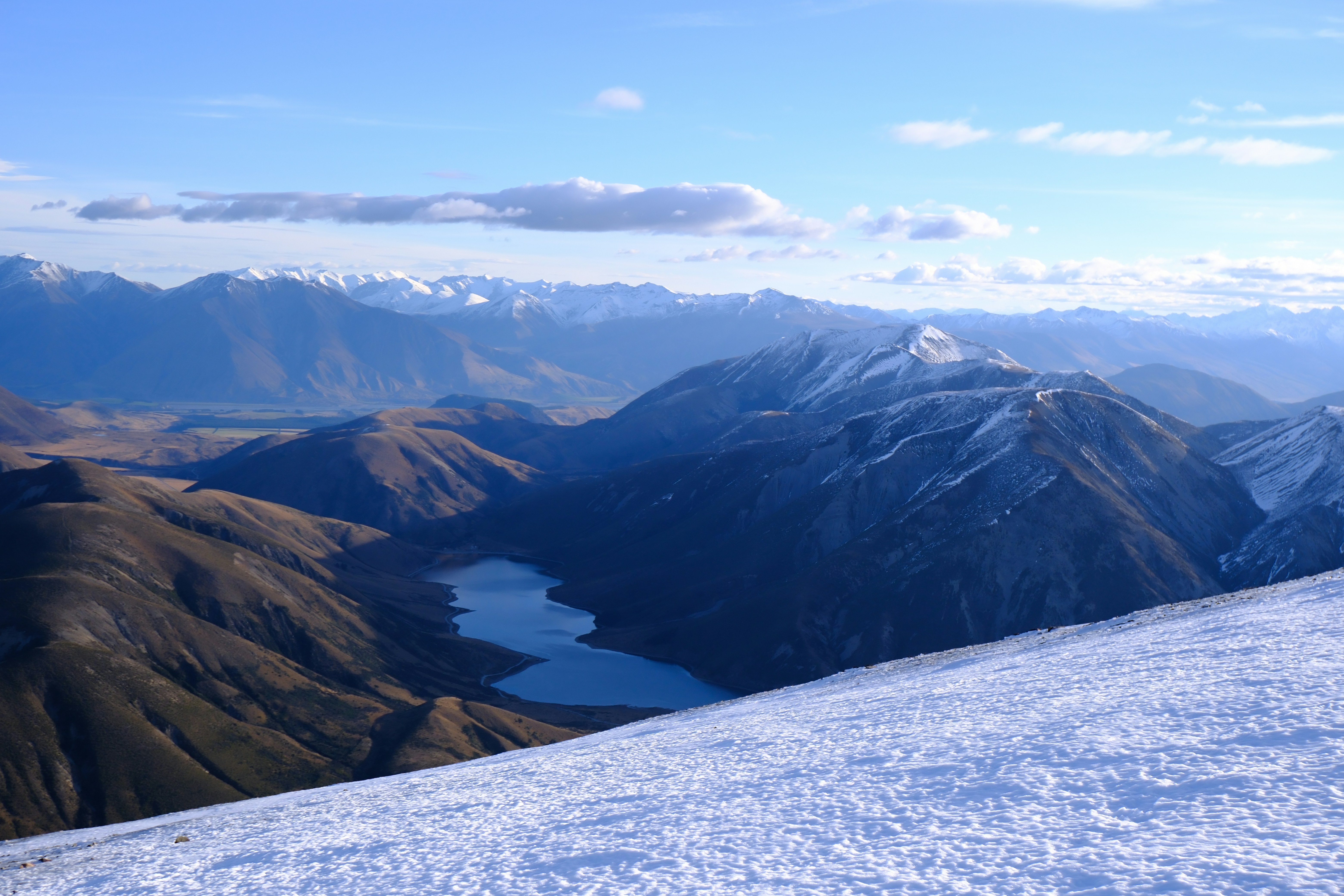 Snowbound Ridge Overlooking a Valley of Rivers and Peaks