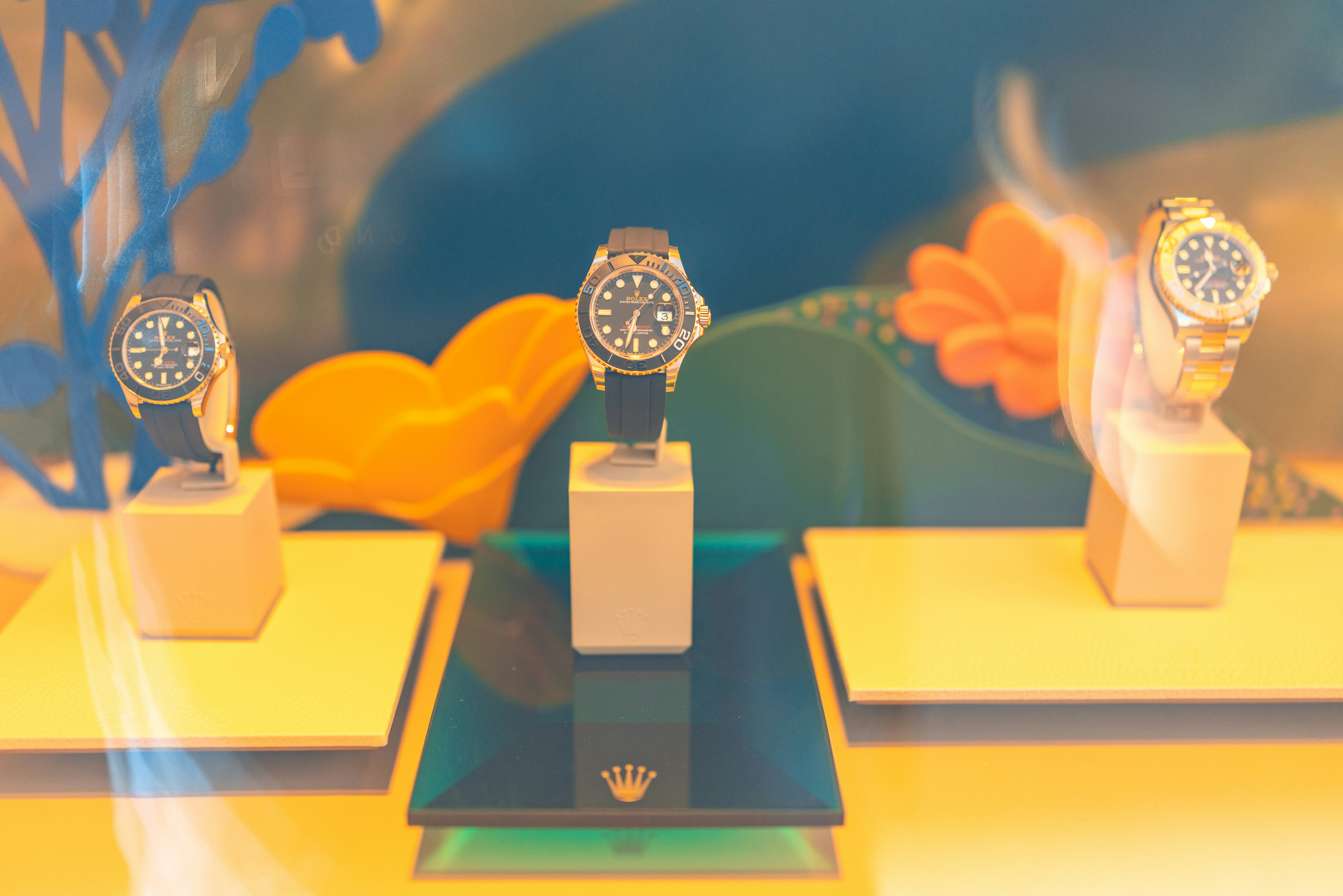 Three Luxury Timepieces on Display with Soft Color Glow