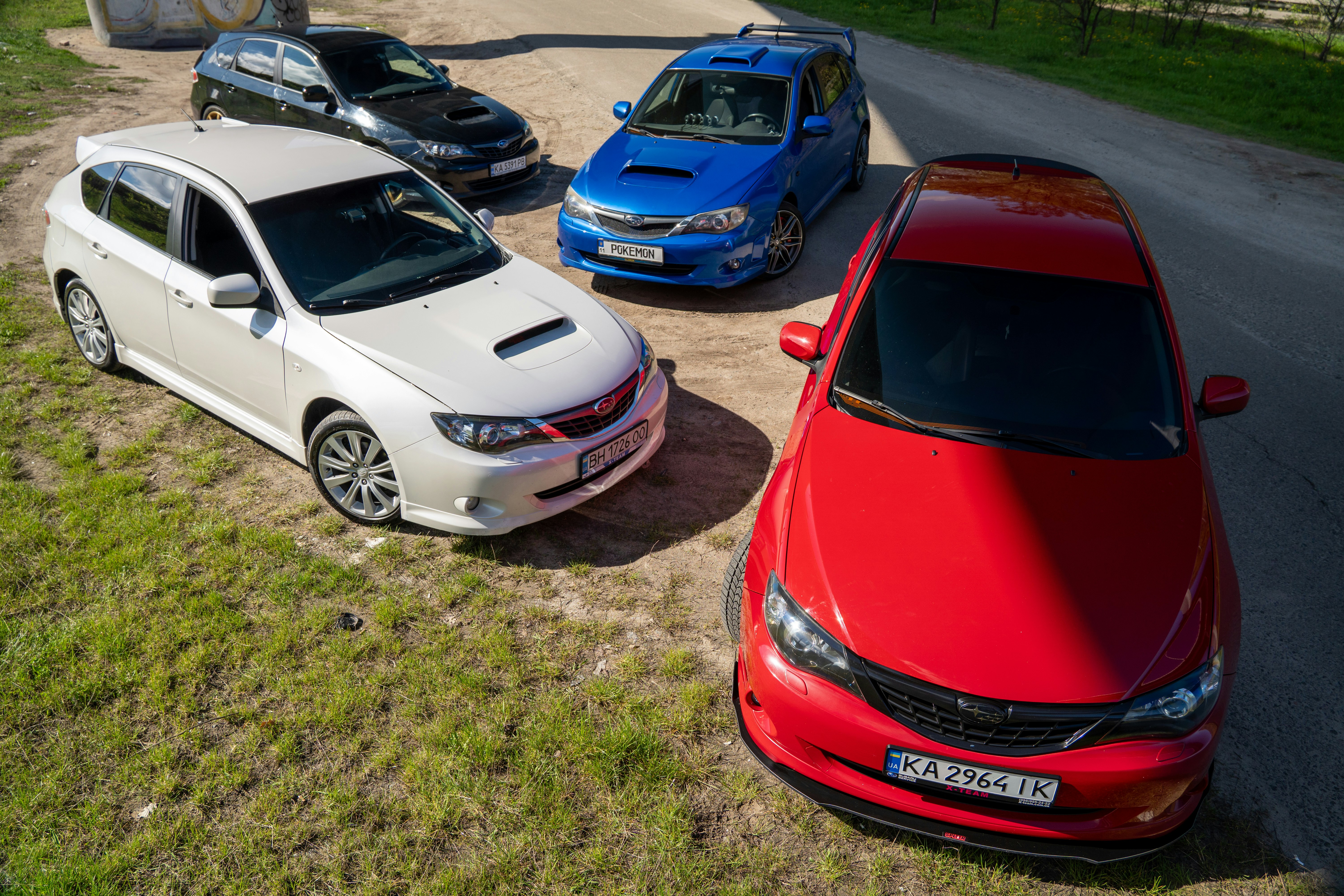 Three parked hatchbacks from a drone's-eye view