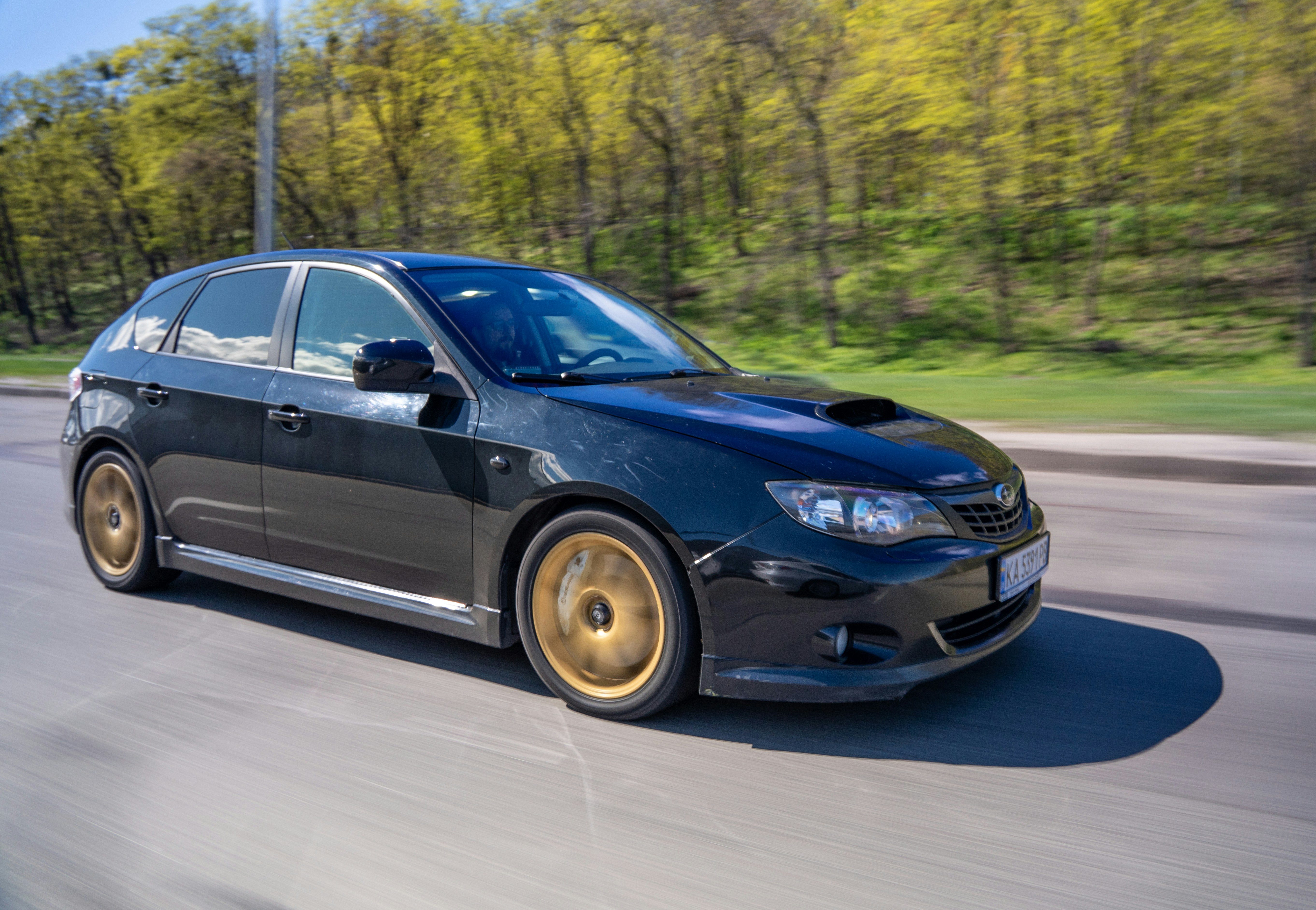 Golden Wheels in Motion: A Dark Drift under Spring Skies