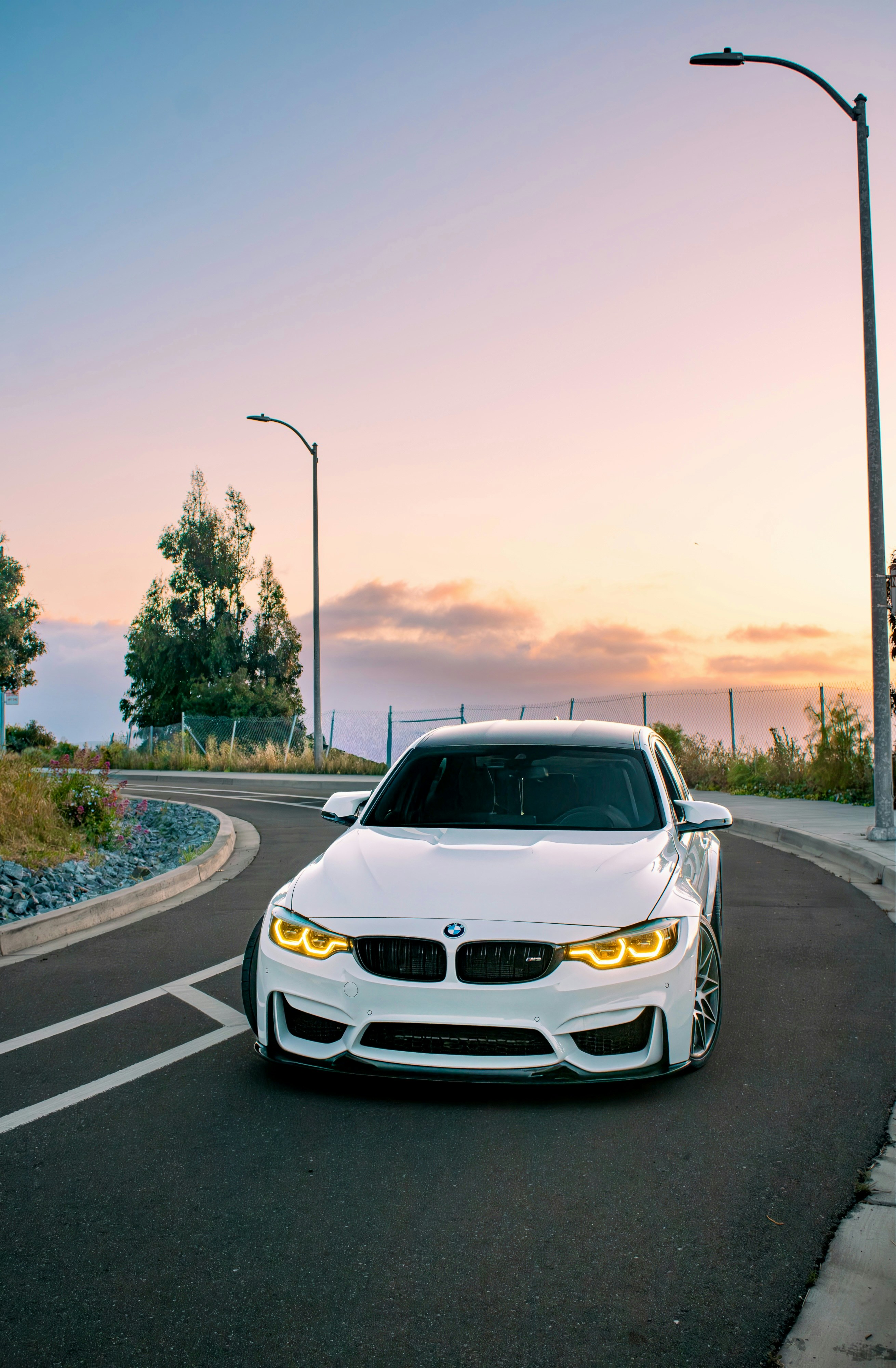 Low-angle Stance: White BMW at Sunset Curve