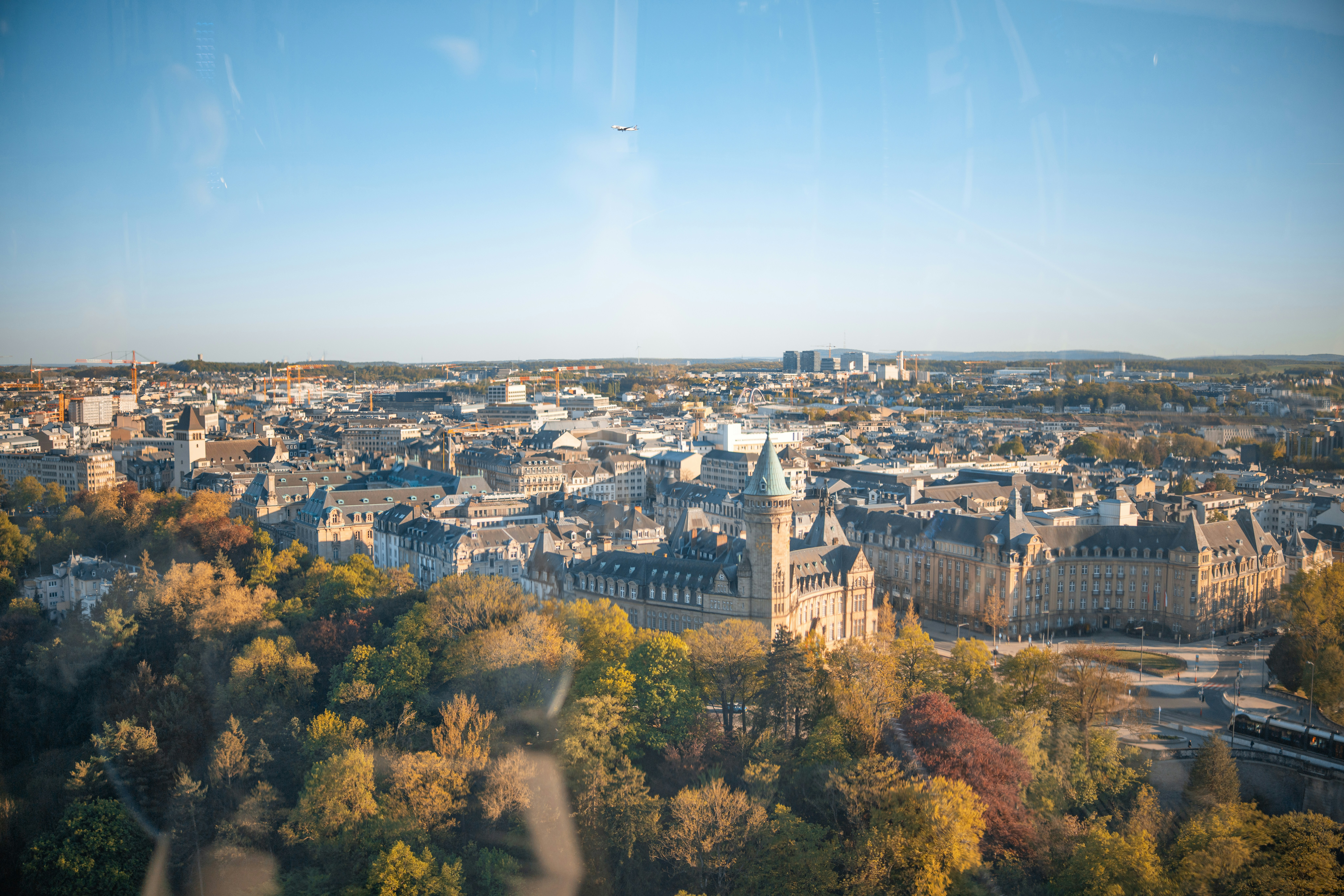 Aerial view over a European city: autumn trees framing a historic skyline