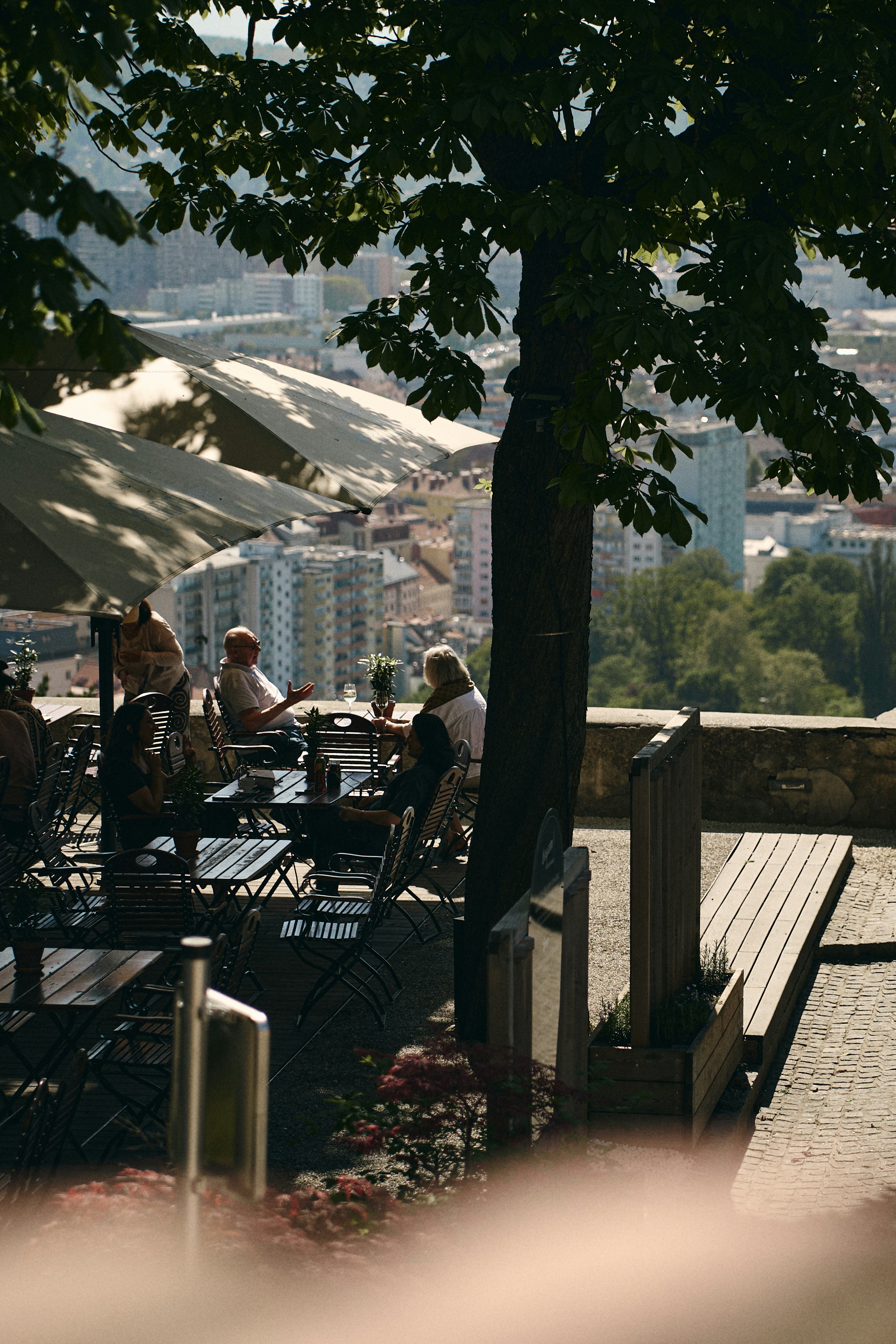 Shadowed Terrace Bistro Overlooking a Distant City