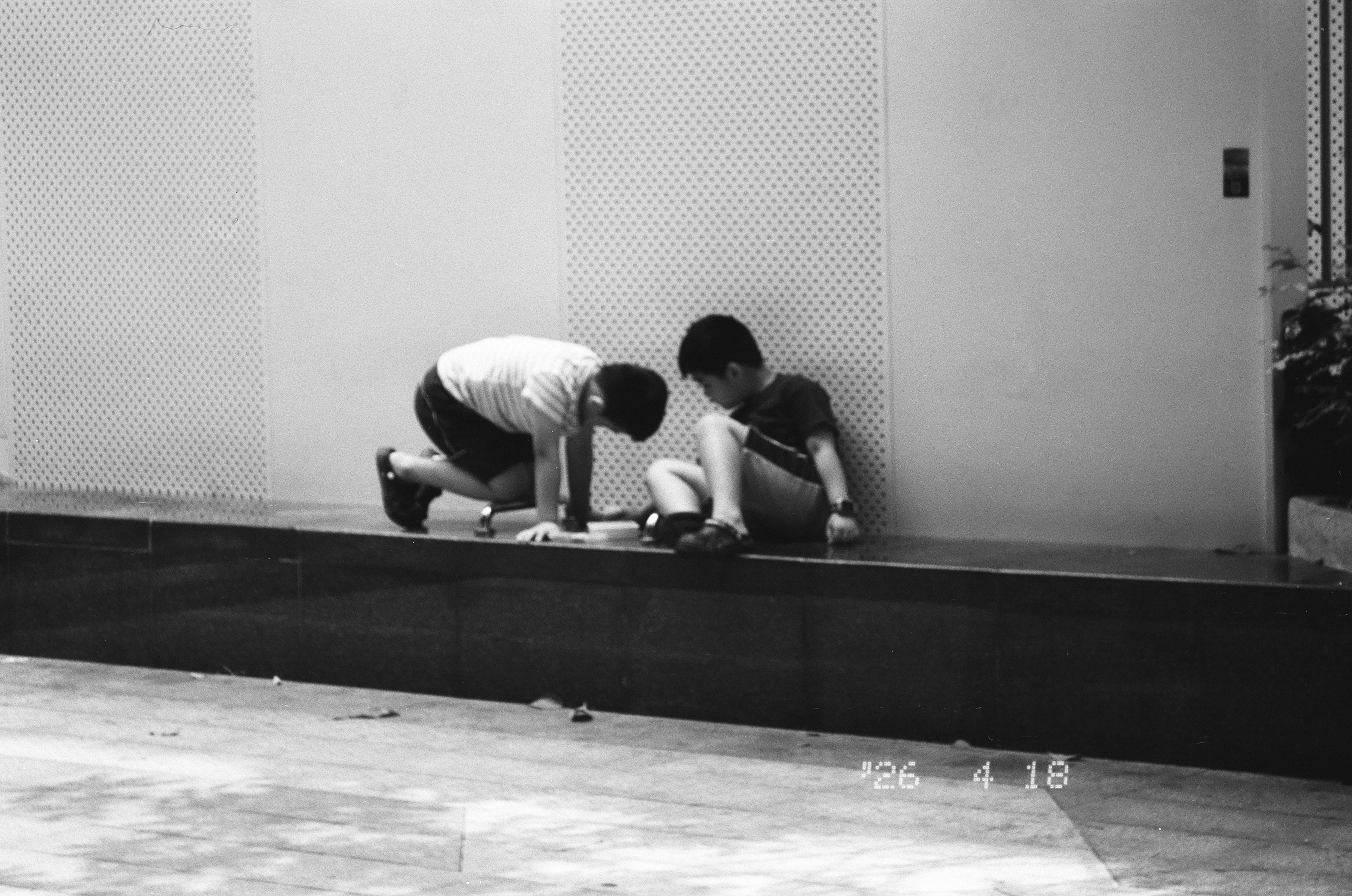 Three Curious Hands: playfully exploring the edge of a tiled ledge