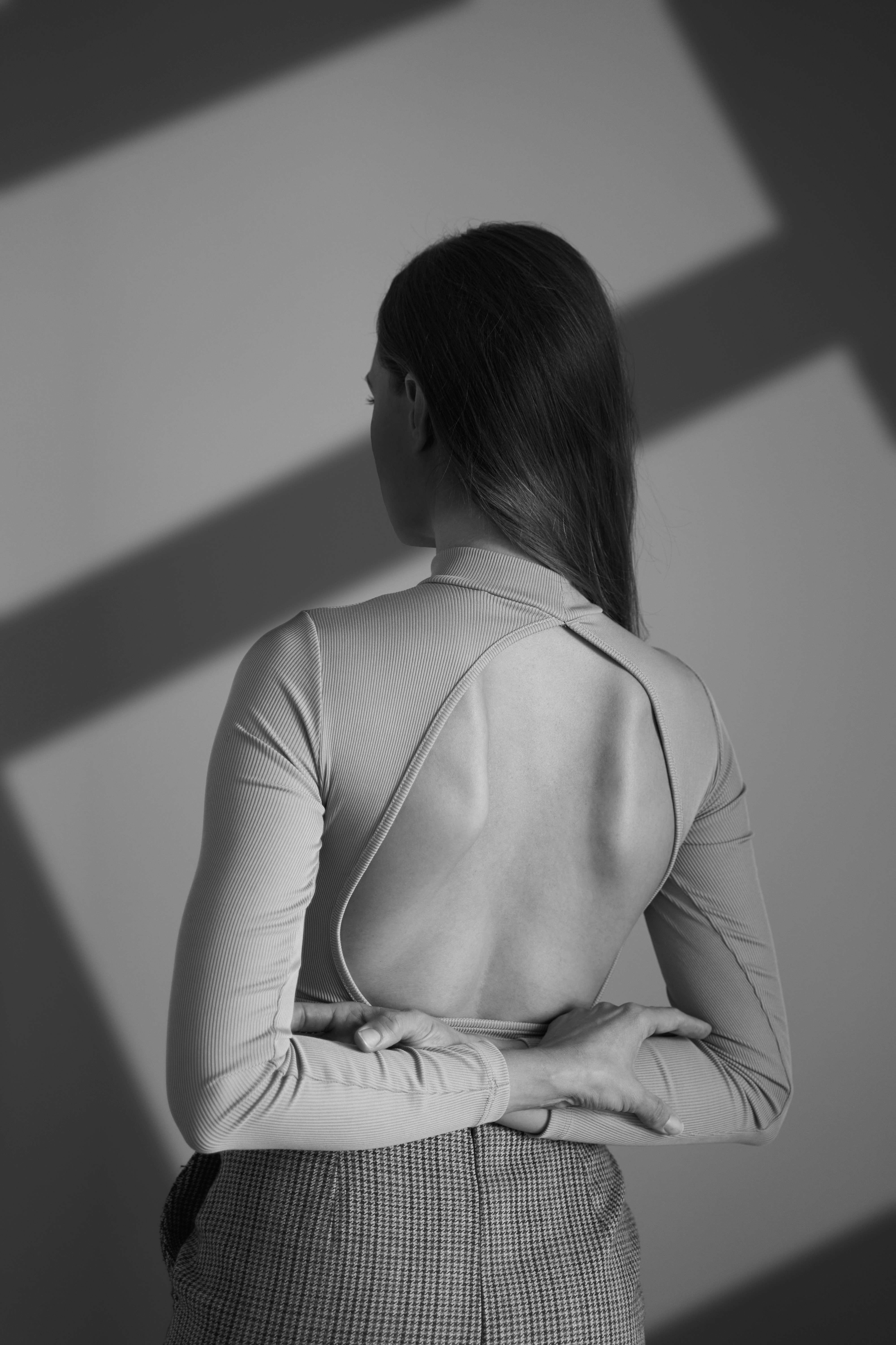Back View in Shadowed Light: A Quiet Portrait of Form and Fabric