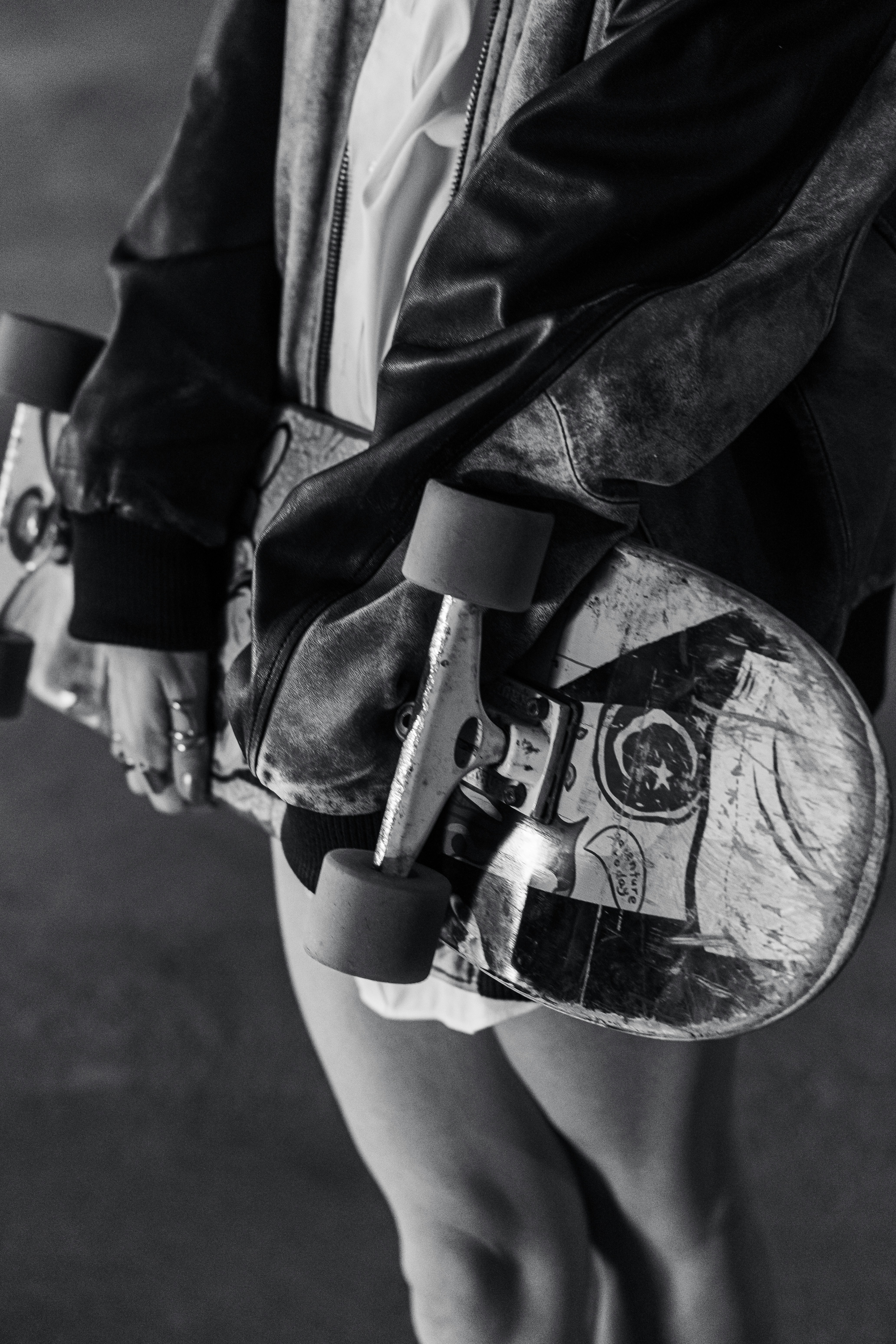 Skateboarder’s Gear: A Grungy Close–Up of a Deck in Black and White