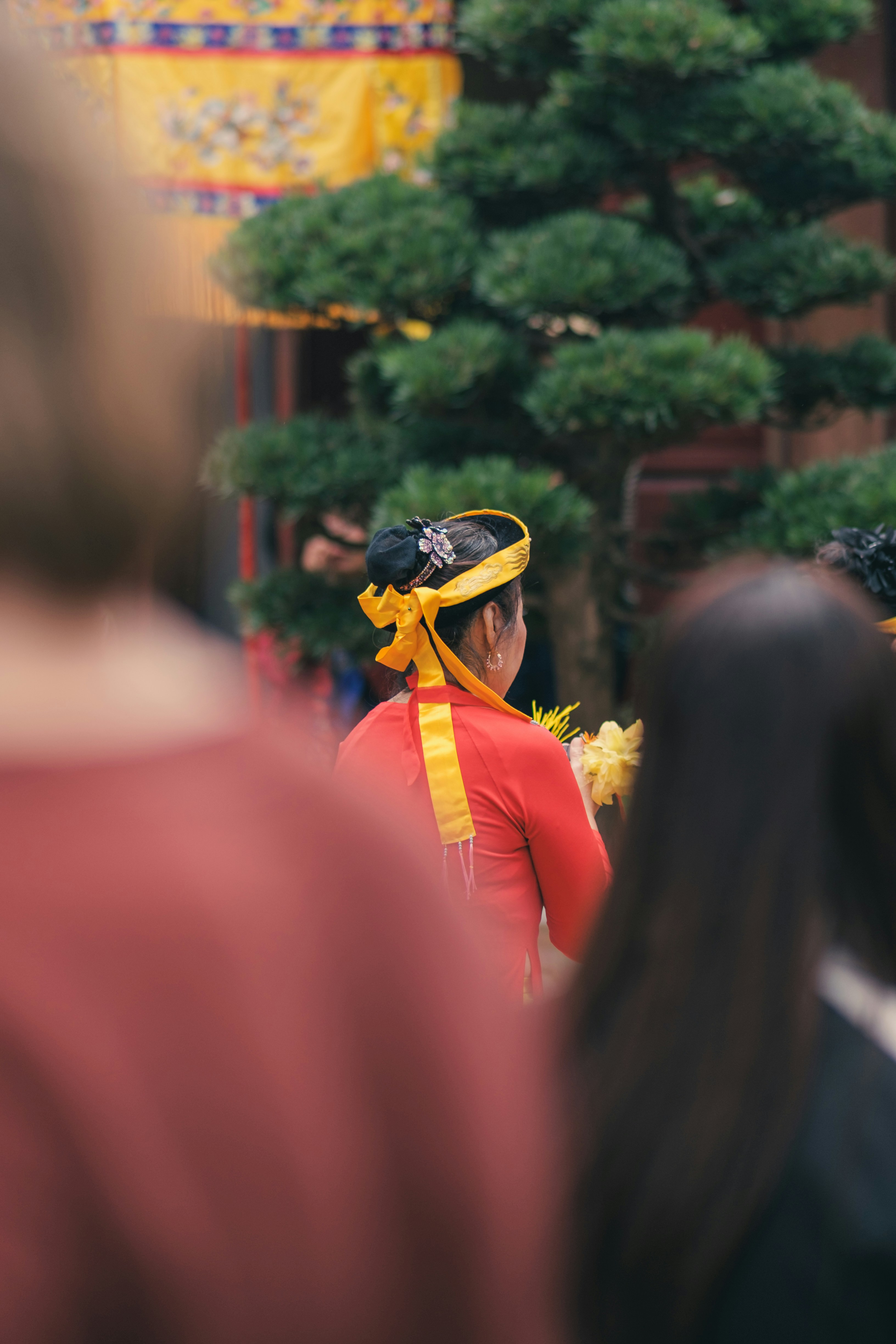 Yellow Ribbon, Red Garb: A Moment at the Festival Shrine