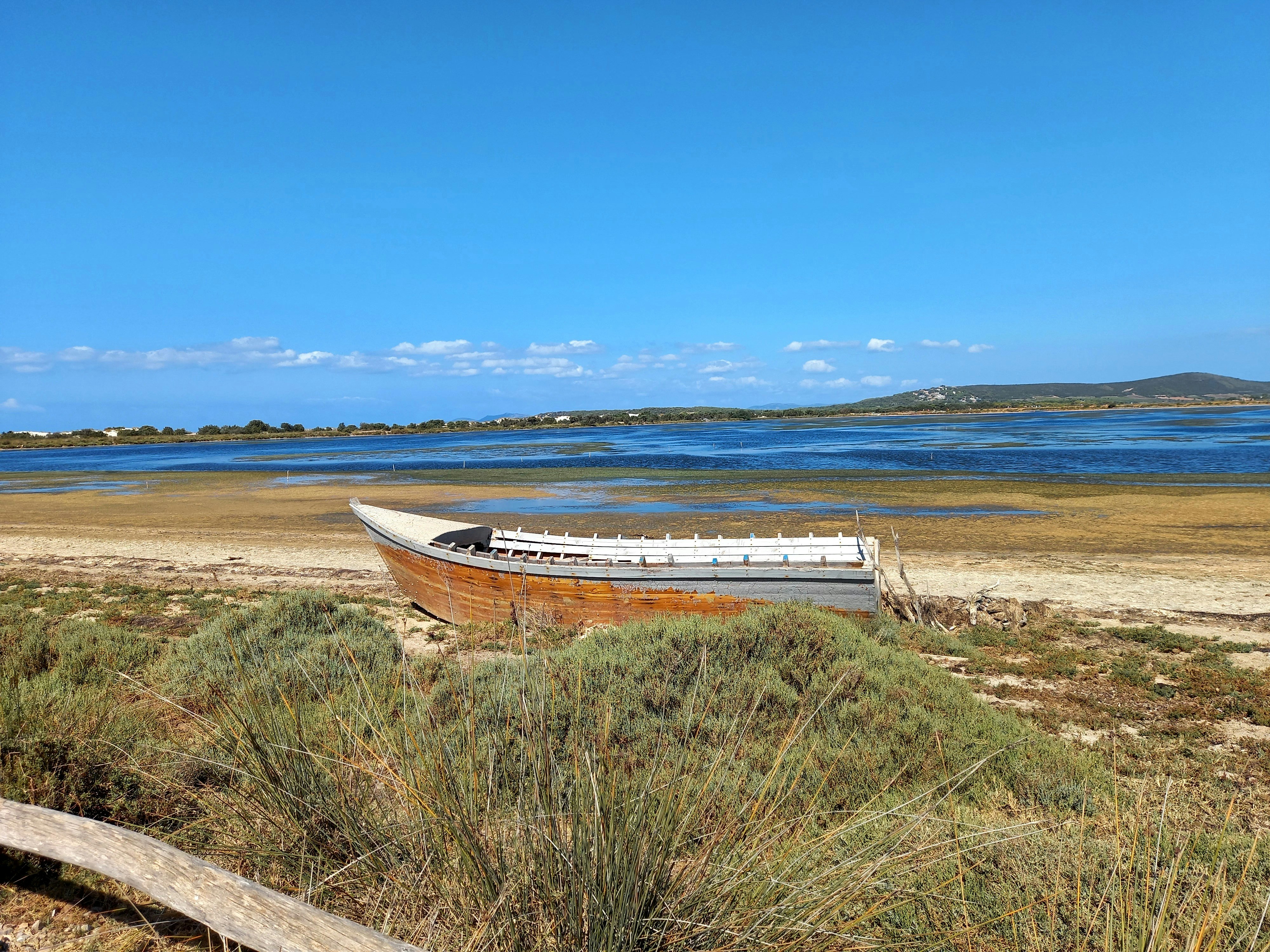 Boat on the Shallow Shore Under Broad Blue Sky