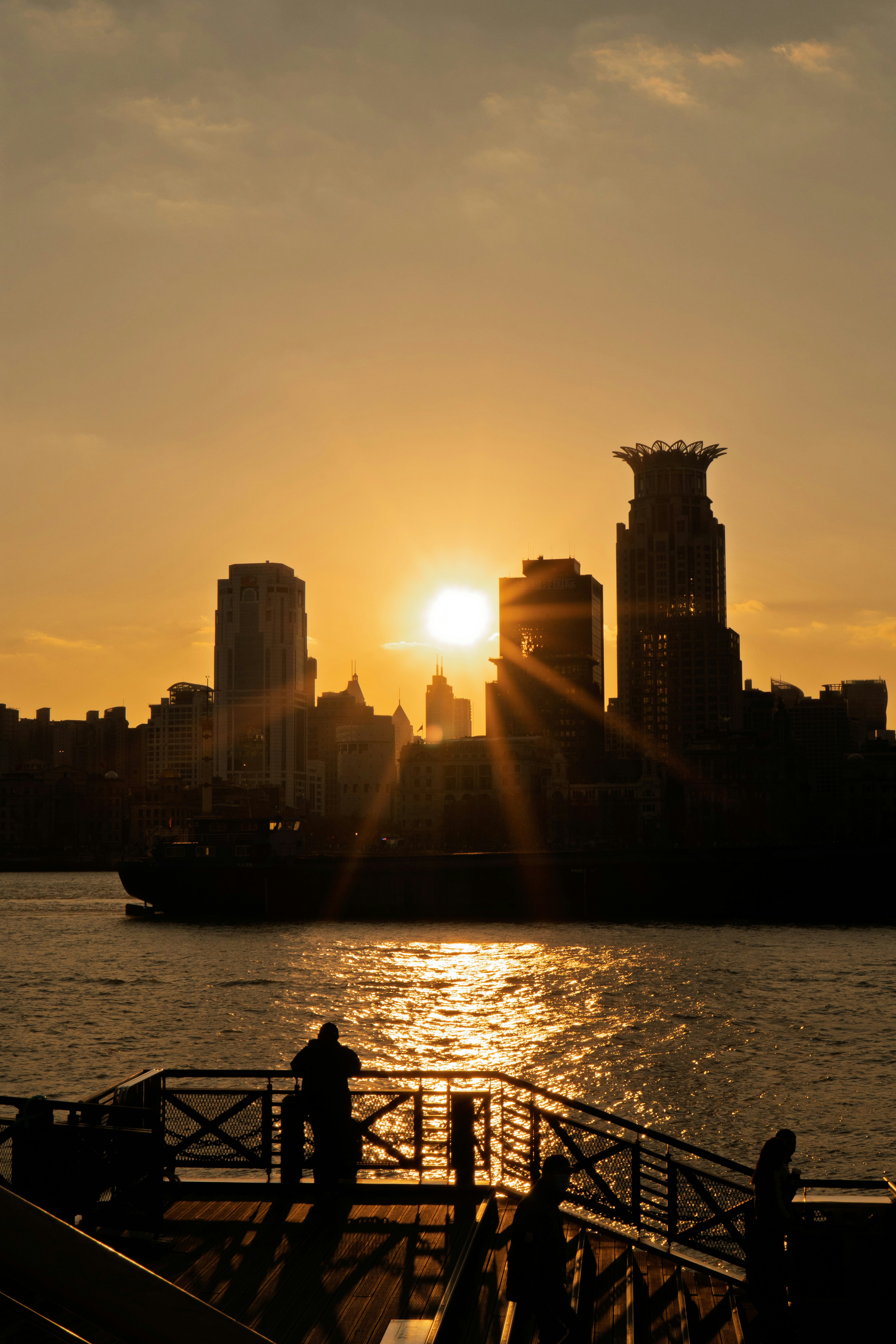 Sunlit silhouette over a harbor bridge at golden hour
