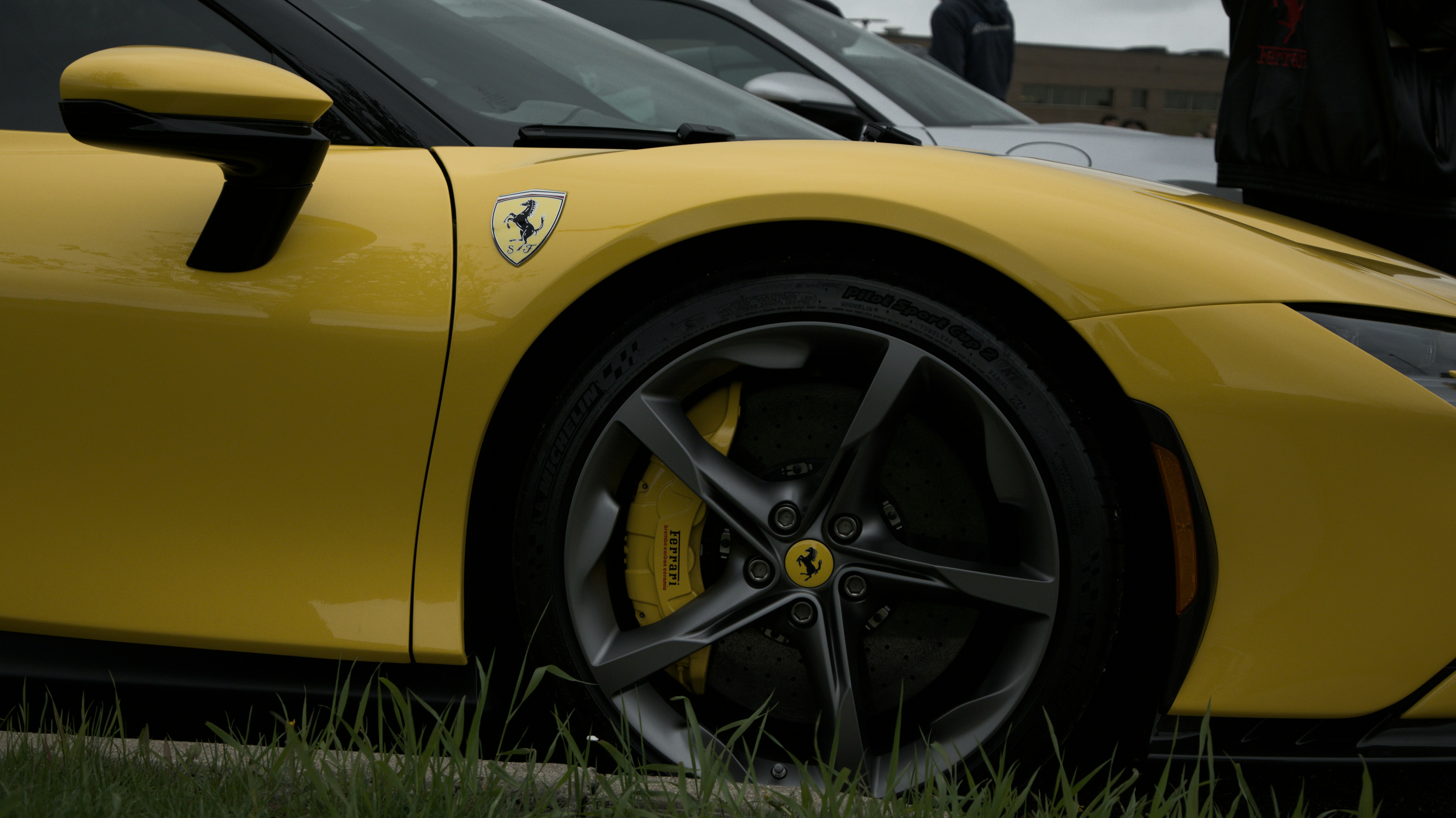 Ferrari Yellow: Close-Up of a Sports Car Wheel and Emblem