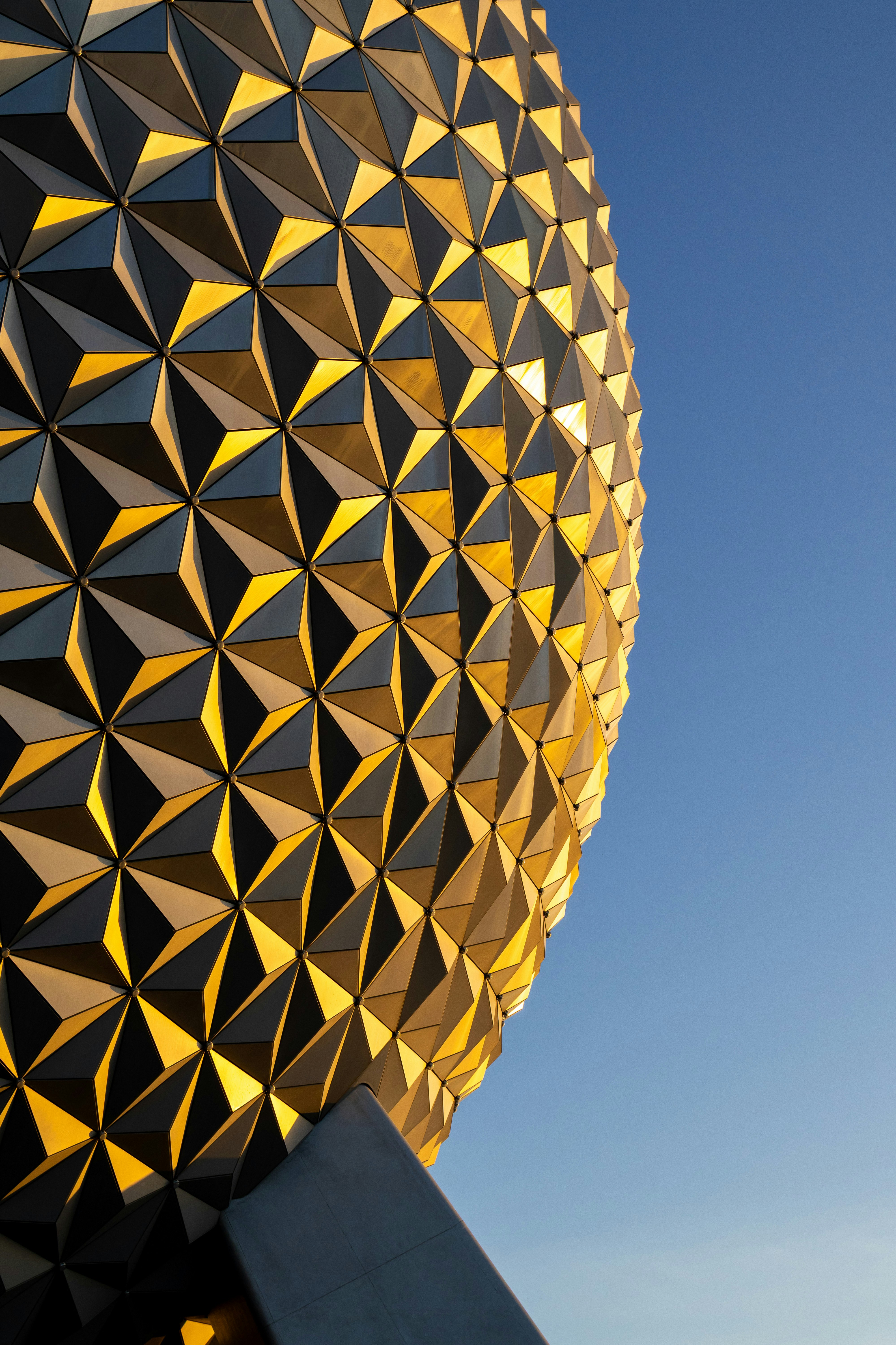 Golden Geometrics: tessellated sphere glowing against a clear sky