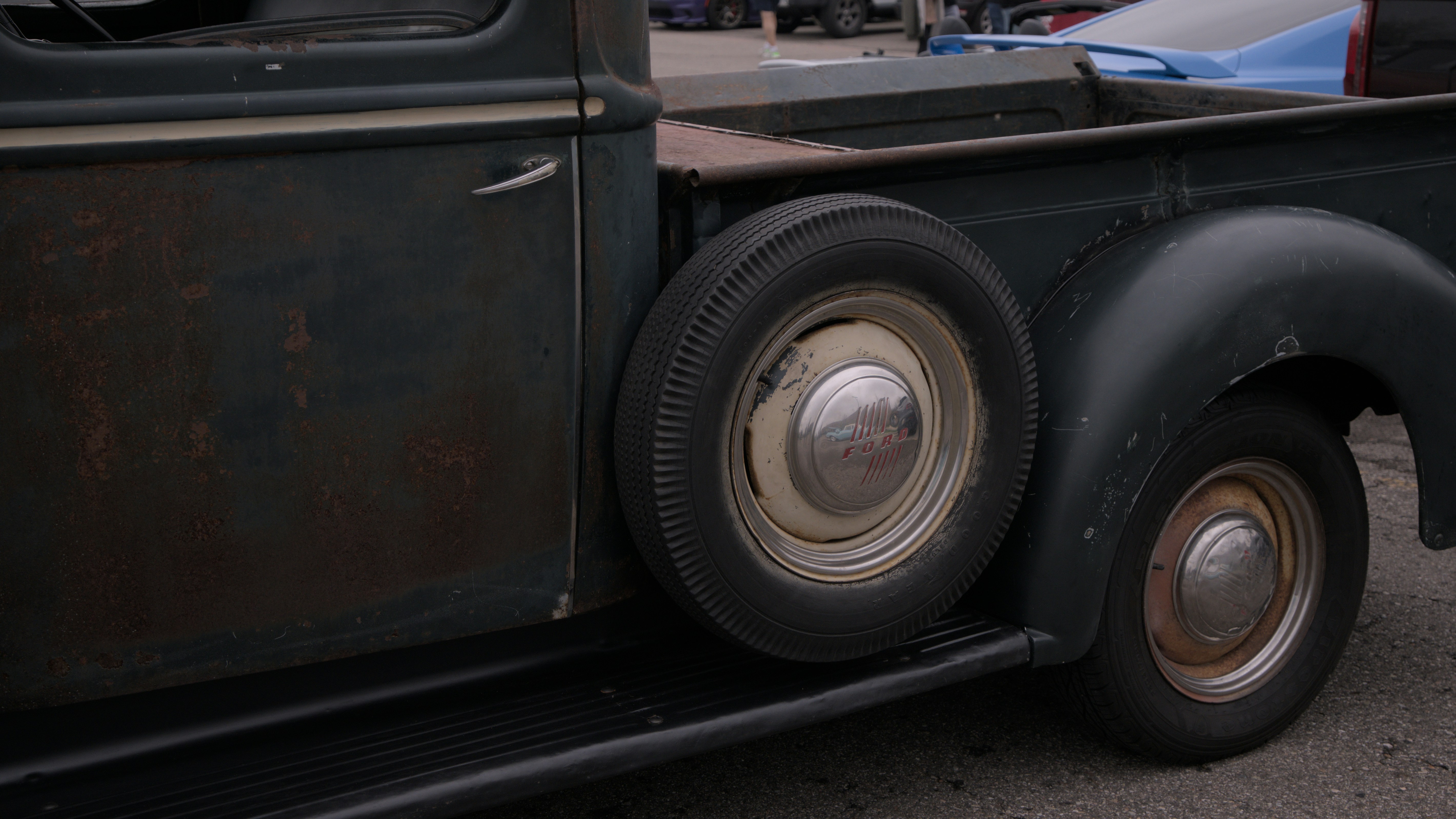 Rusty Legacy: A Truck Wheel and Fenders Worn by Time