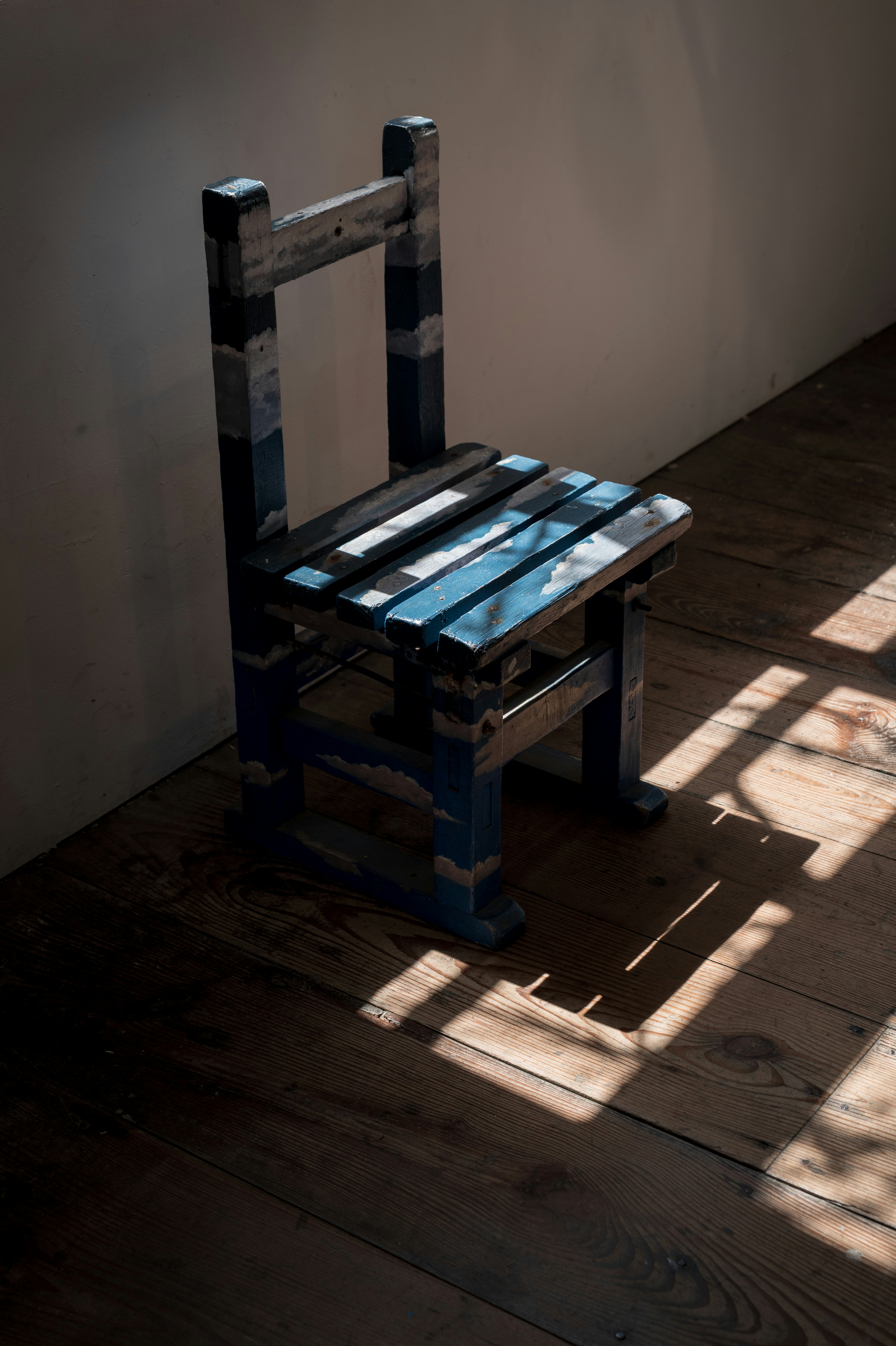 Shadows on a Painted Stool: A Quiet Corner in Sunlit Wood