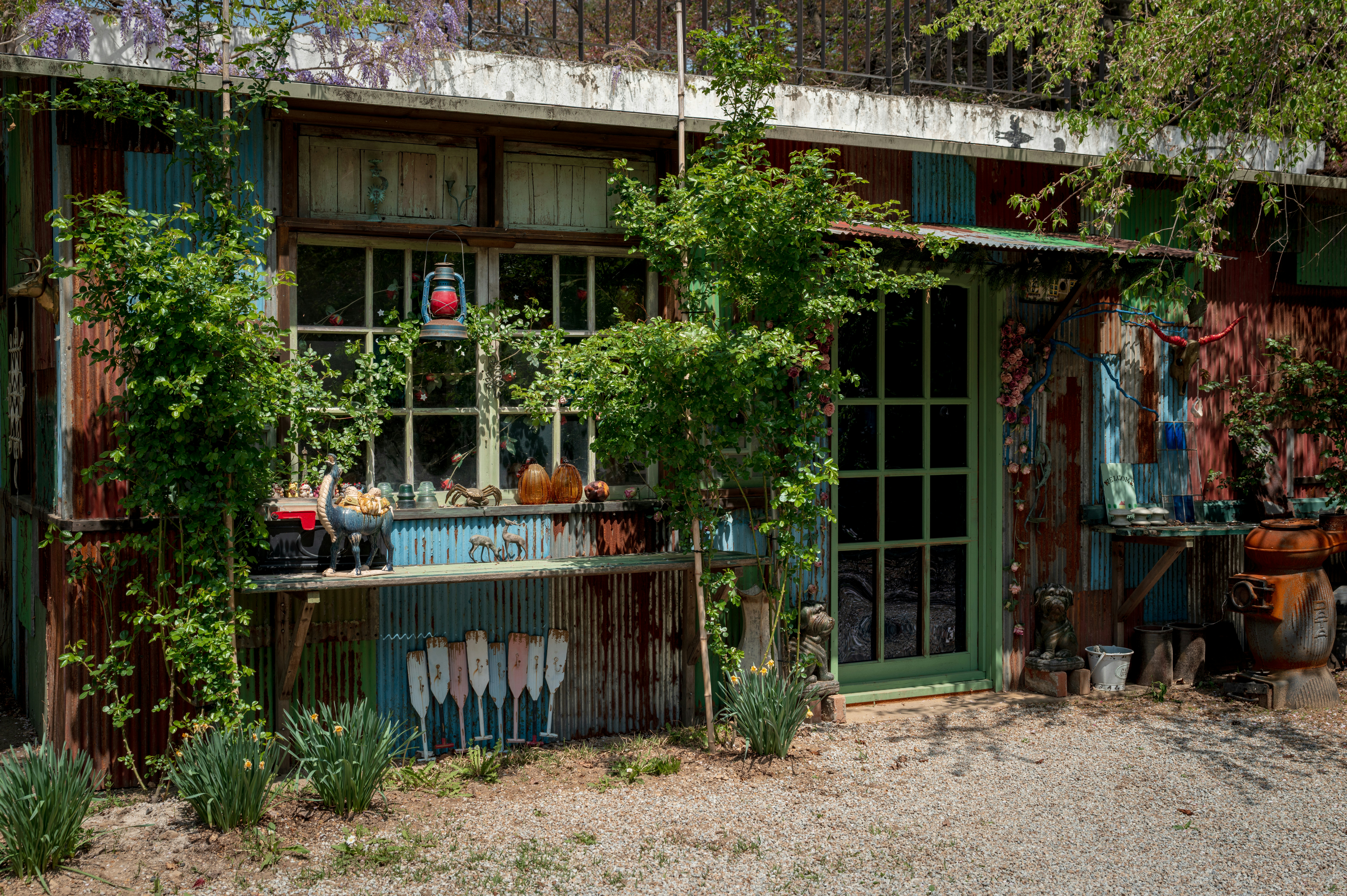 Rustic storefront with garden greens and weathered ceramics