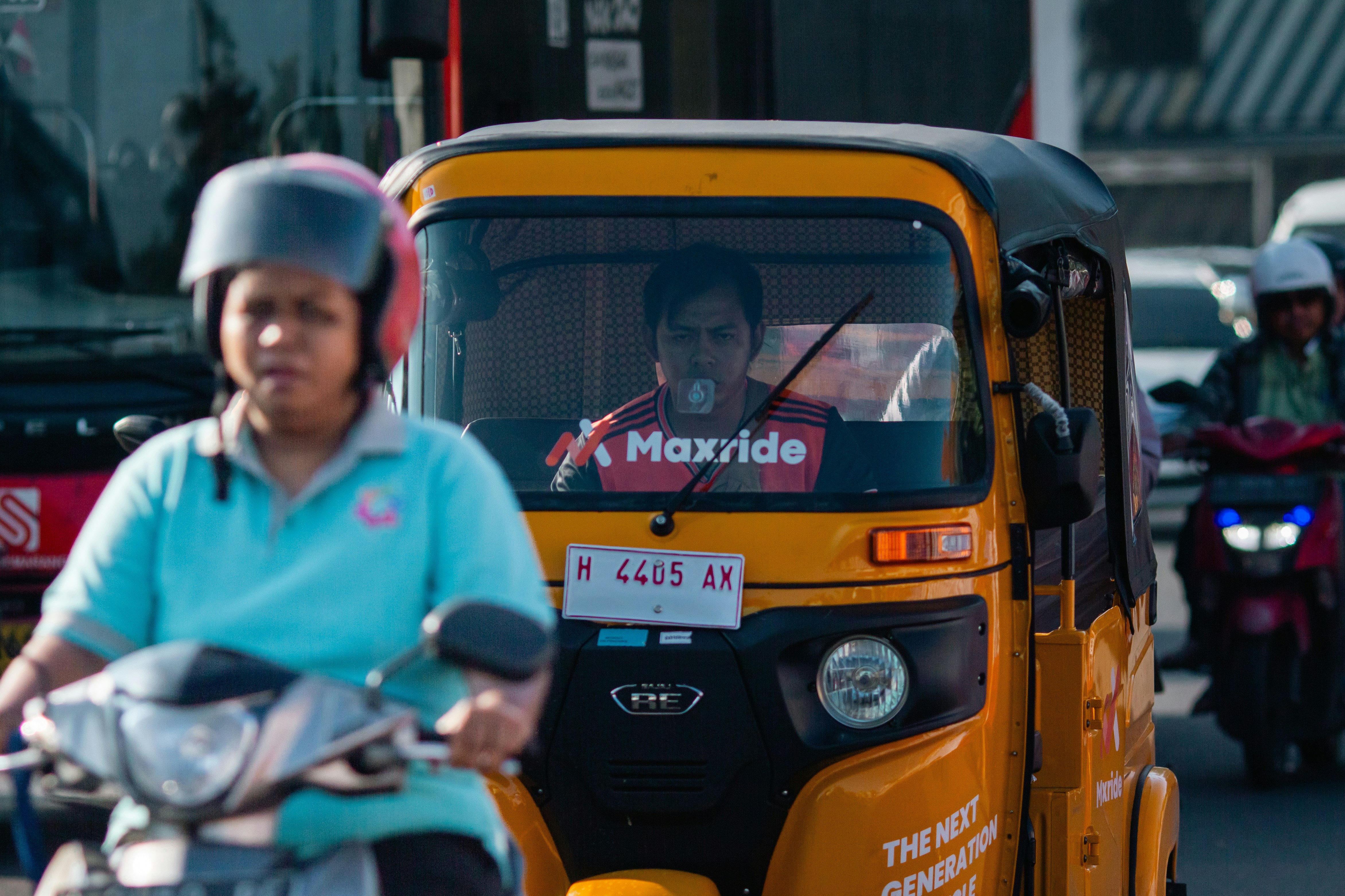 Yellow Tuk-Tuk in Busy Street with Drivers in Motion