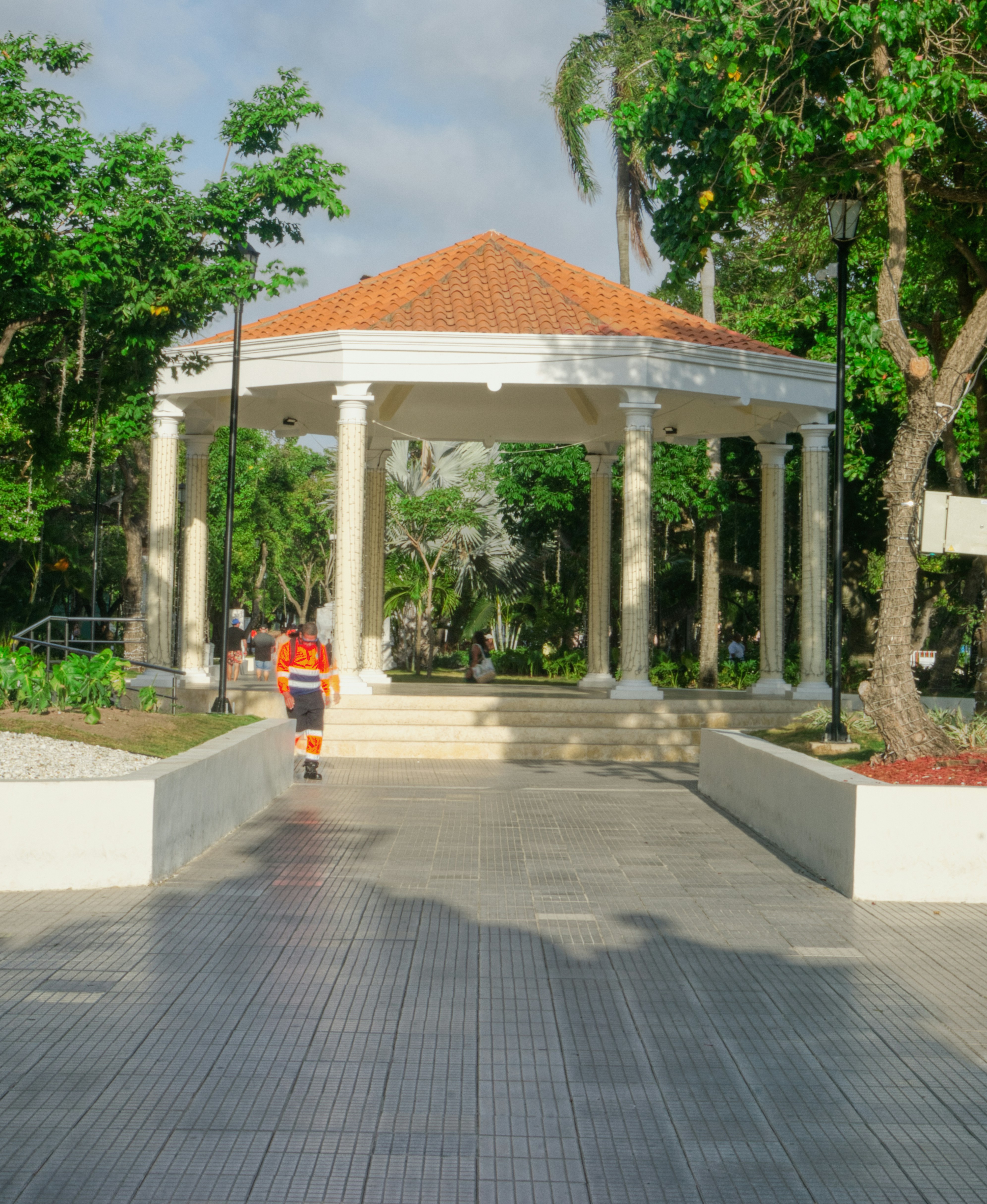 Central Pavilion Pathway: Sunlit Columns and Runner in a Park Corridor